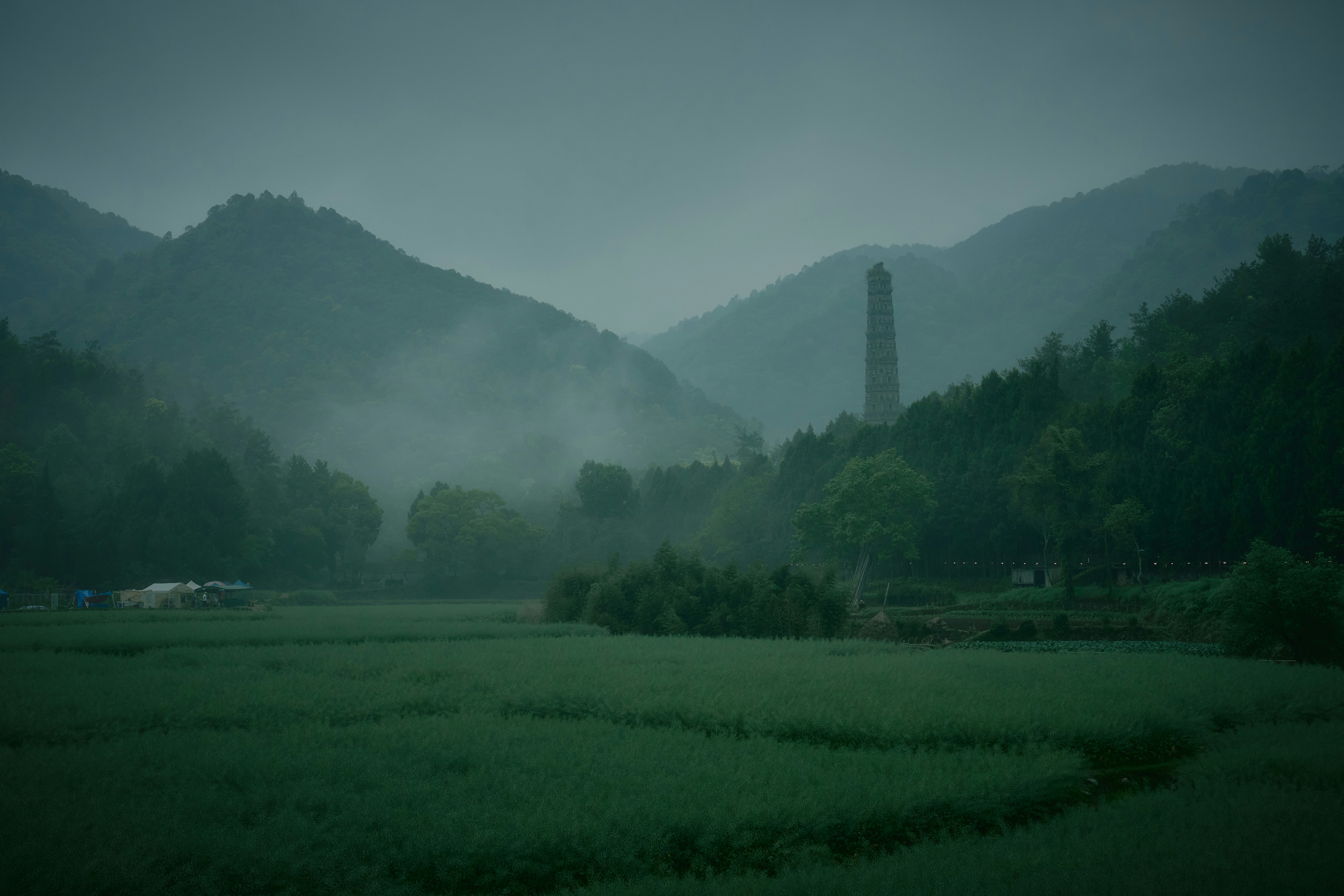 Misty Valley Watchtower Over Green Fields