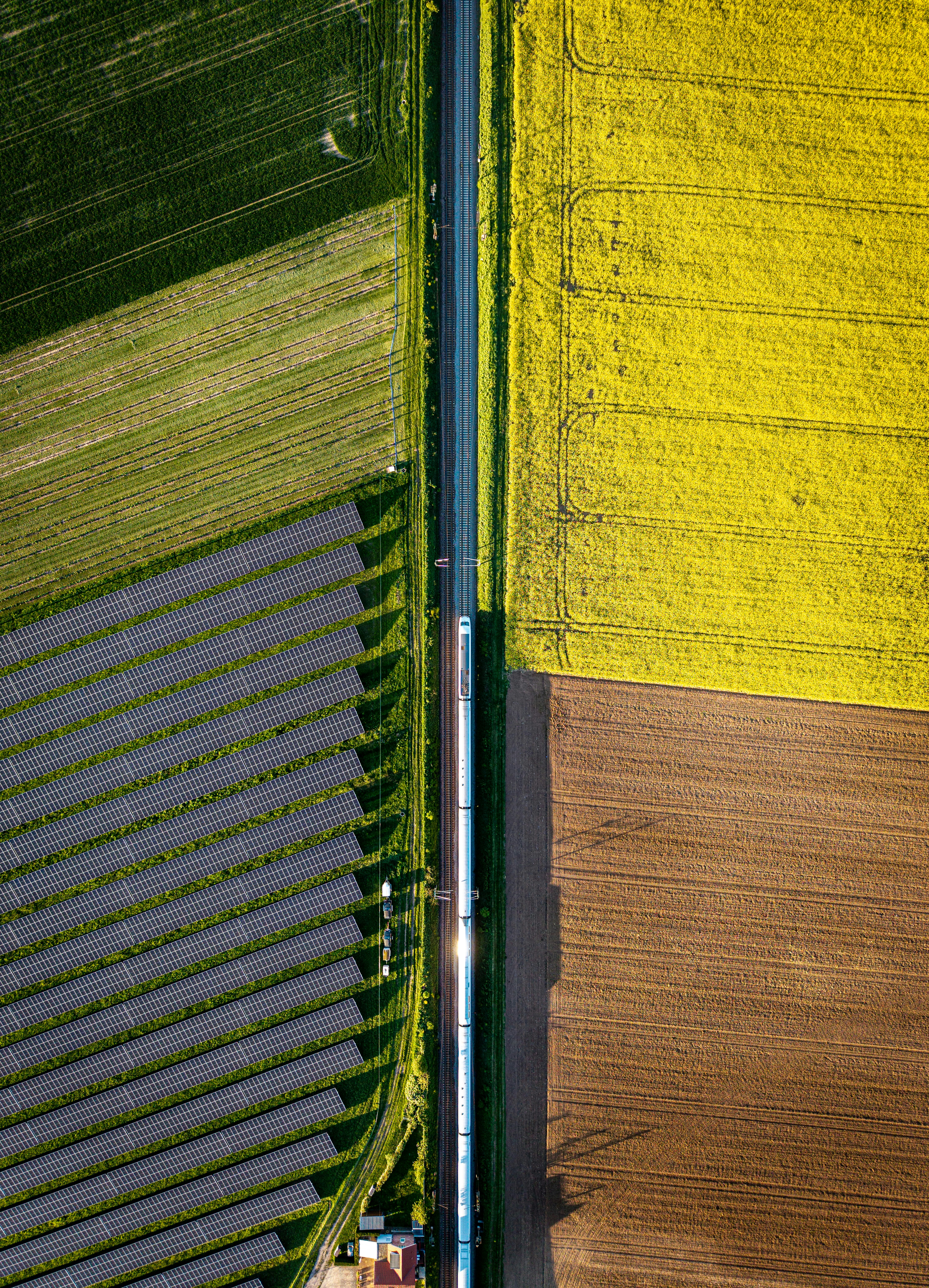 Aerial Corridor: Train and Fields Divided by a Midnight Road
