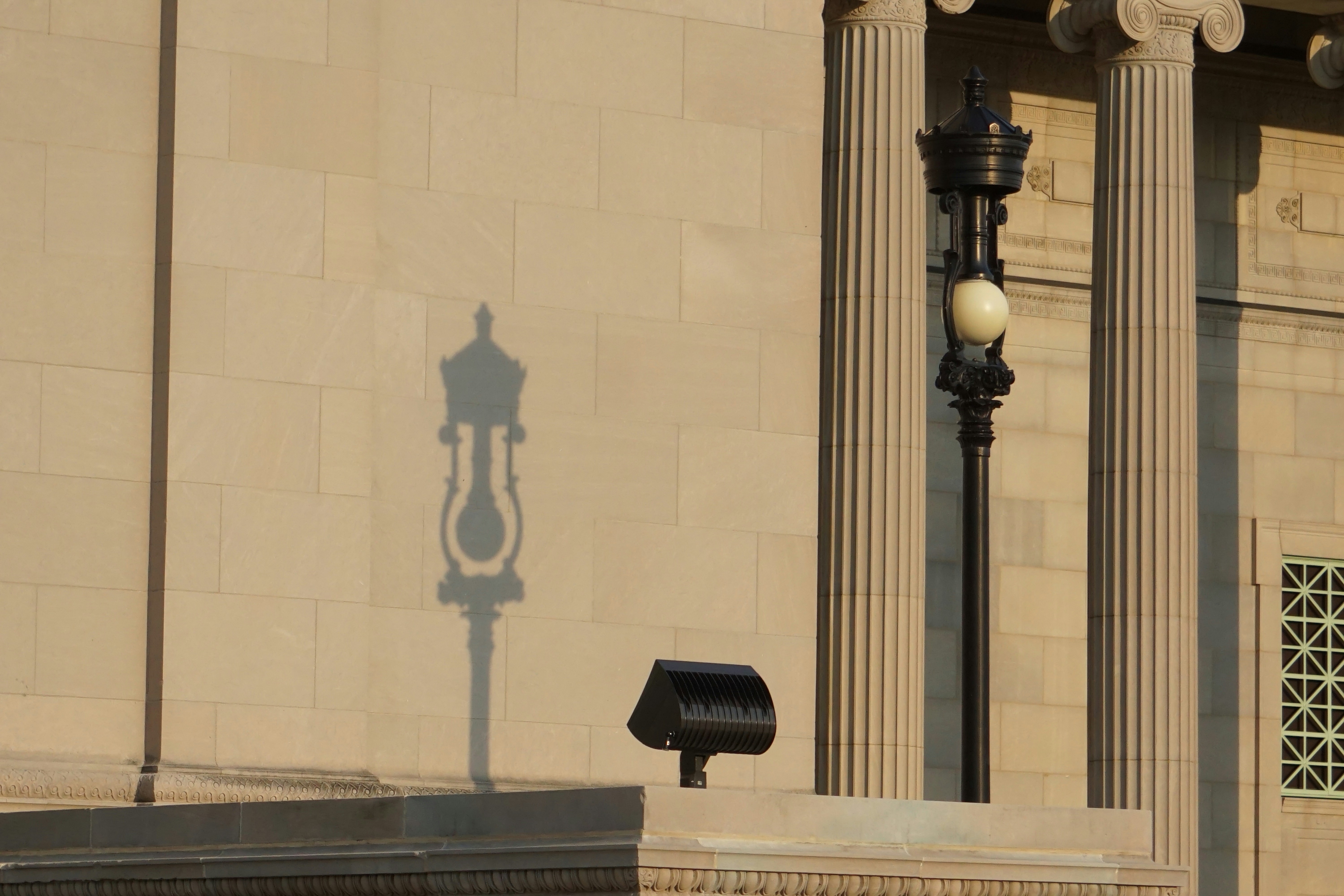 Sunlit Courthouse Facade: Shadow of the Lamp Post