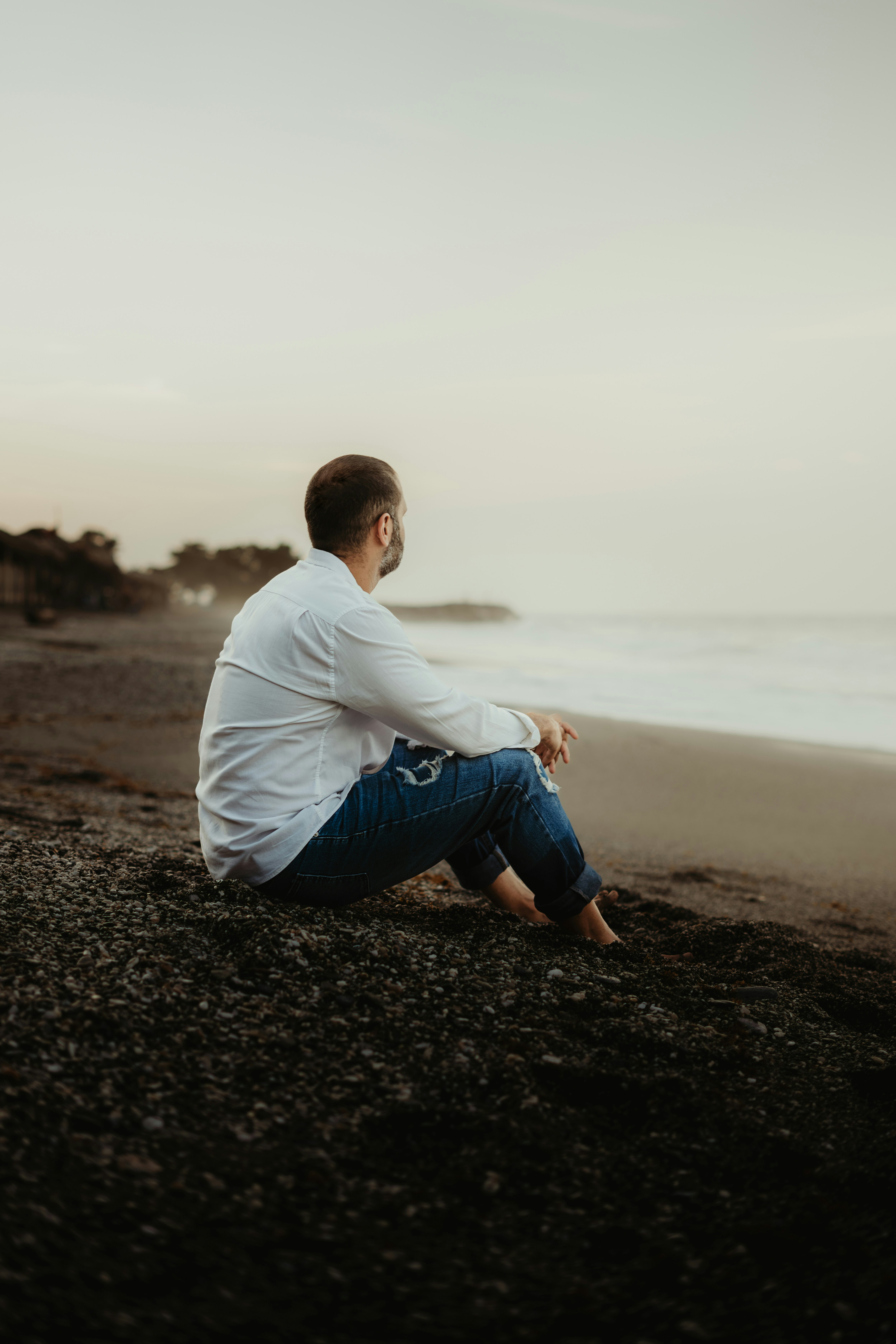 Quiet Solitude: A Man Contemplates the Horizon by the Shore