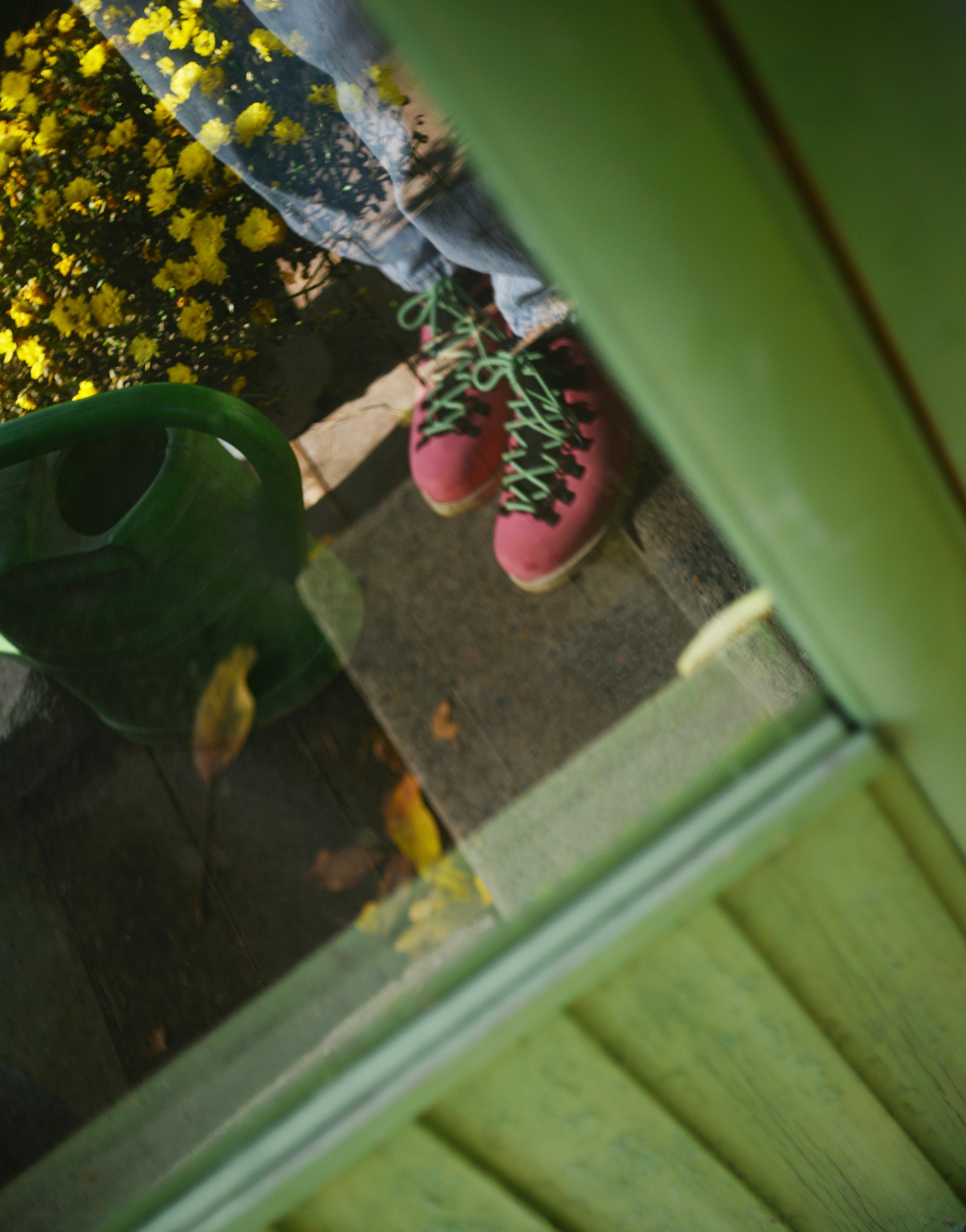 A Quiet Terrace View: Red Shoes by the Green Door
