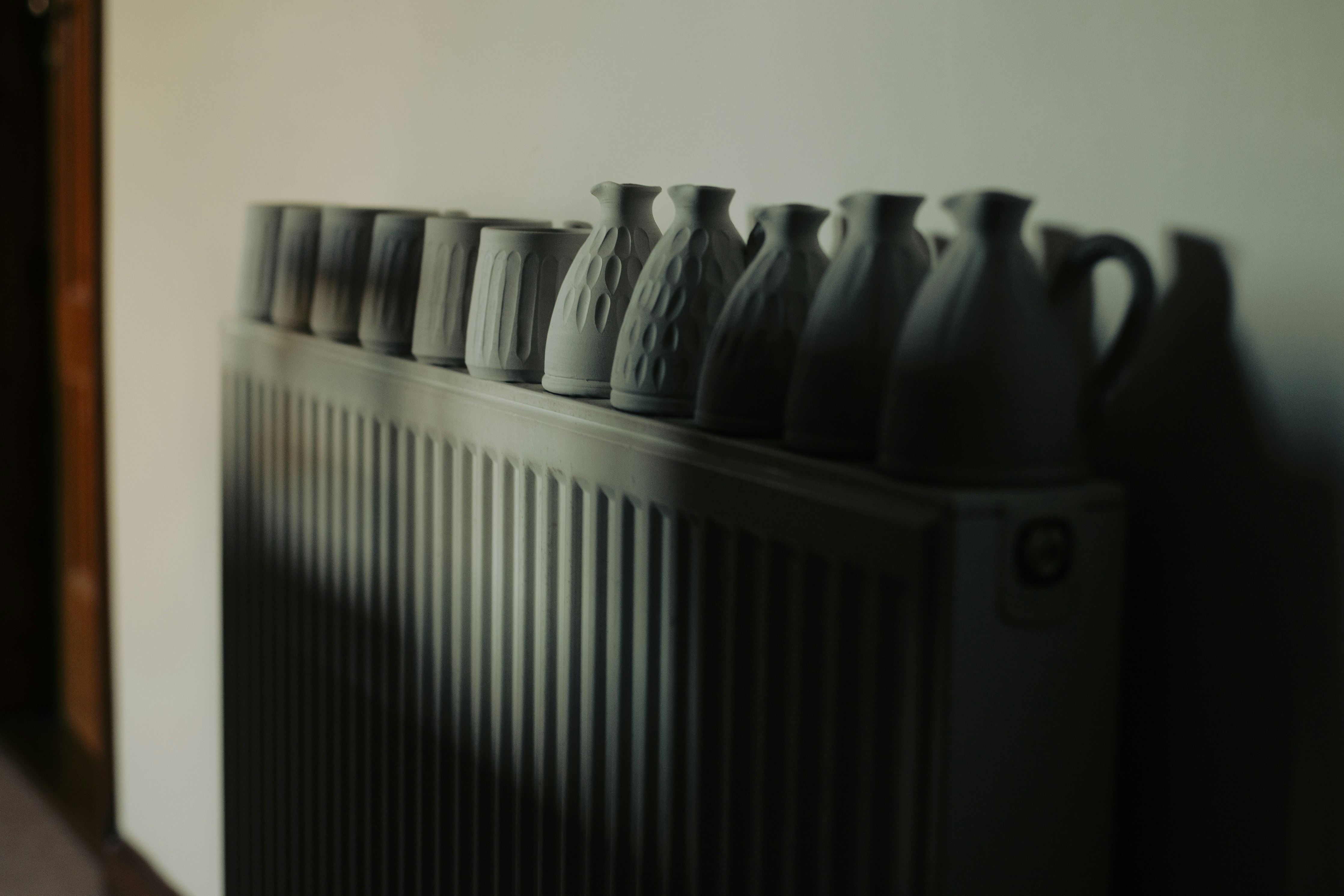 Ridge of Vessels: Evening Light on a Row of Jugs