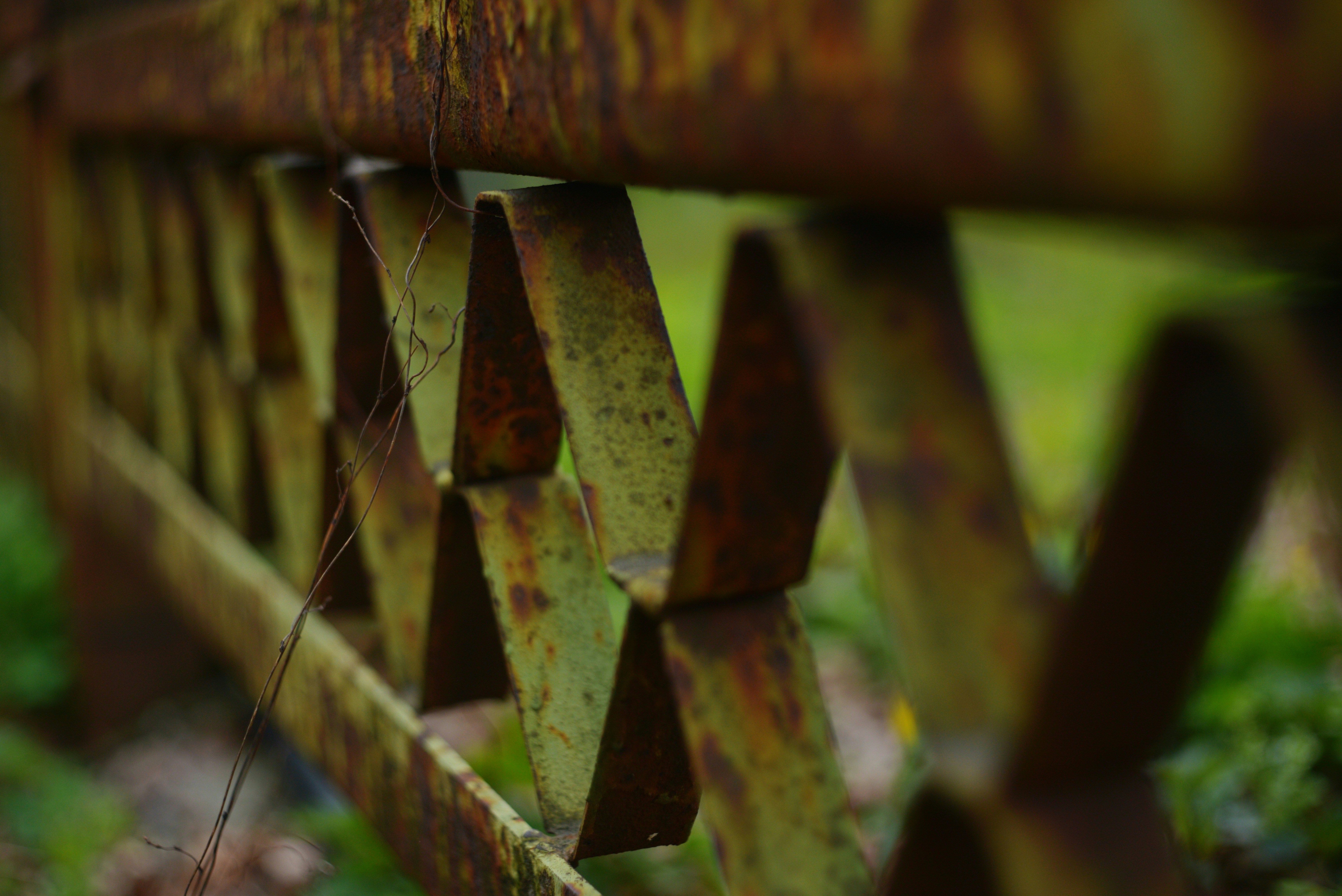 Rusty lattice: close-up of weathered fence diagonals