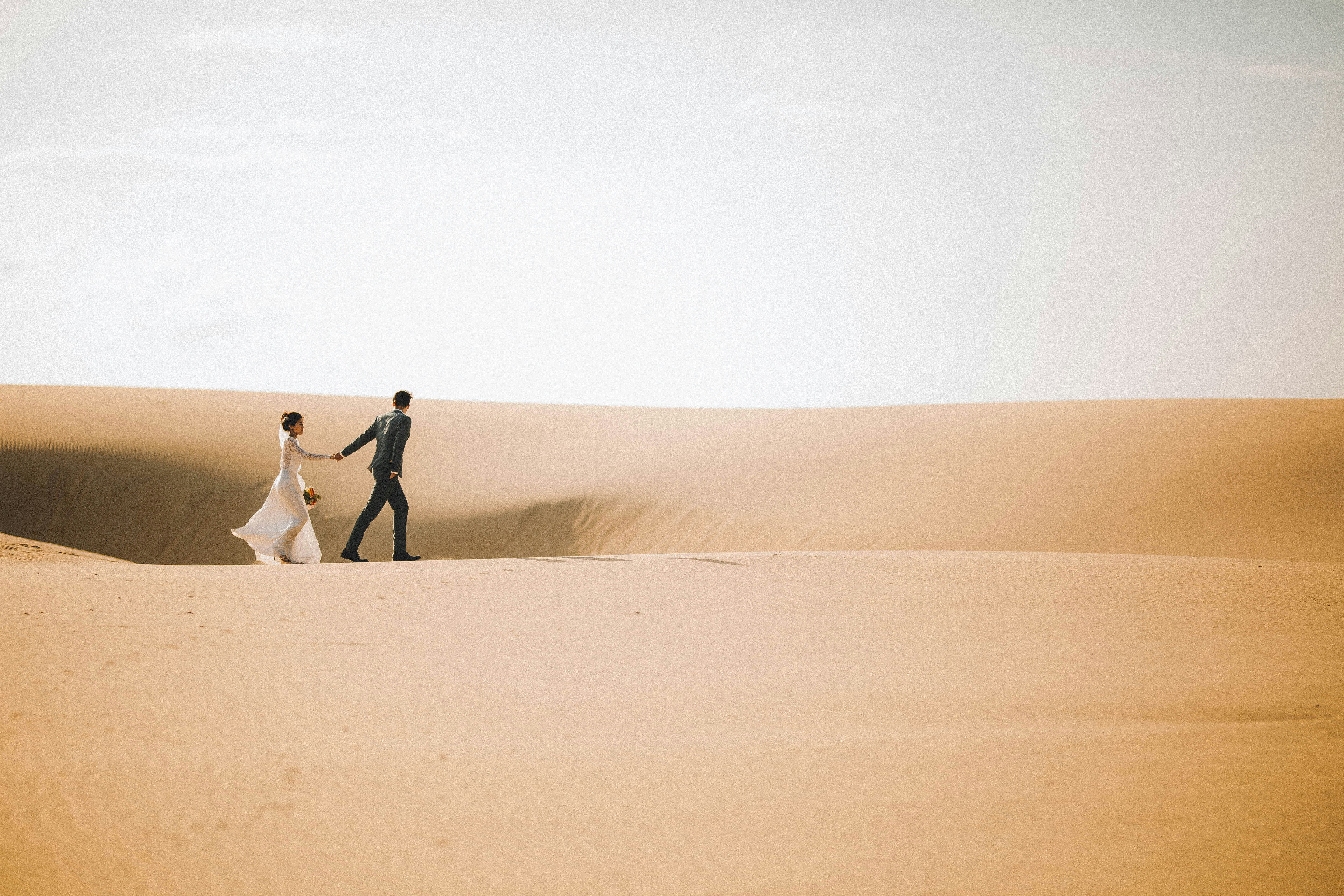 Footsteps Across the Dunes: A Wedding Walk in Desert Light