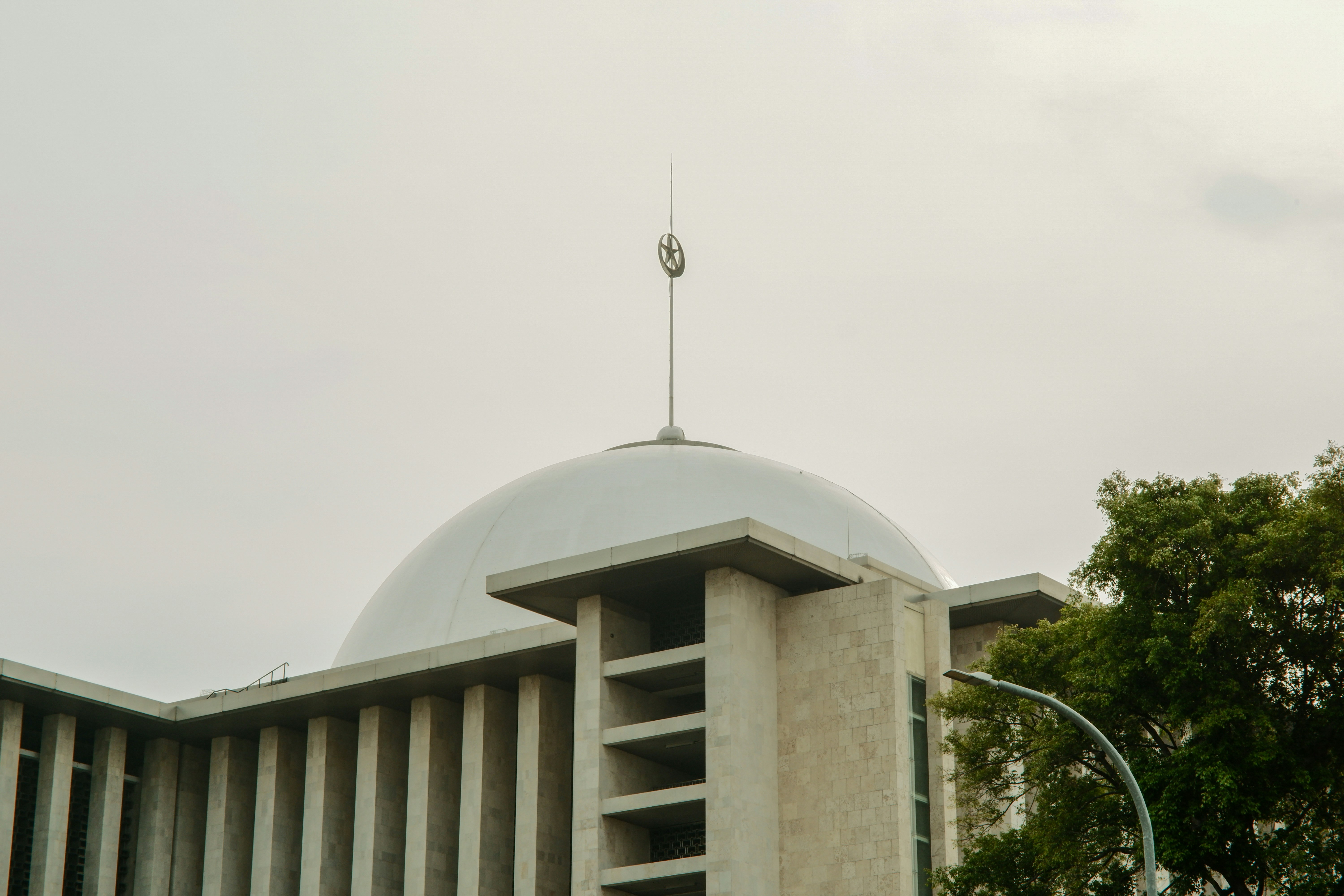 Dome Crest: A Brutalist Tower Surmounts a Concrete Campus Corridor