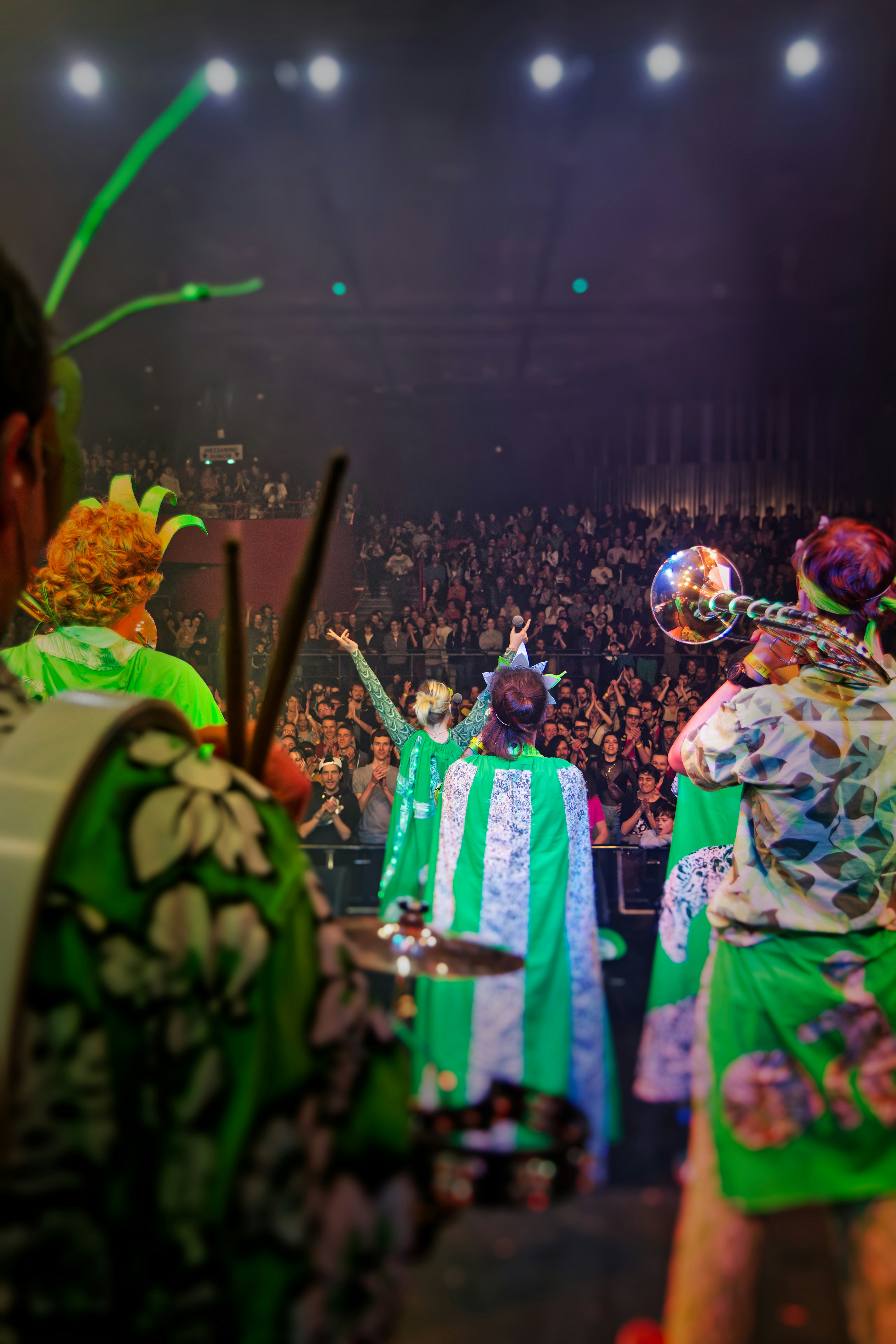 Band on Stage: Neon Backdrop and Crowd in Green-and-White