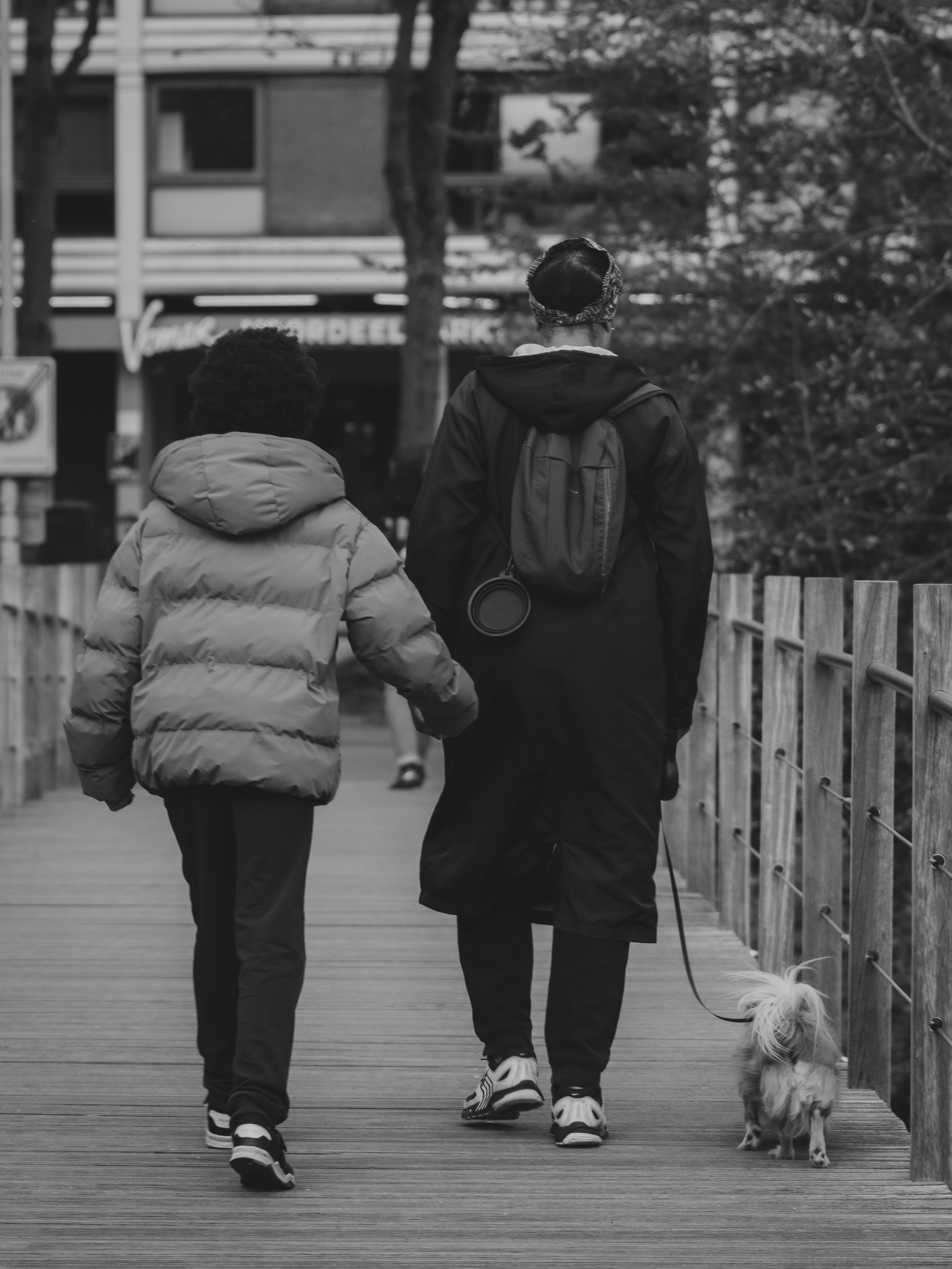 Holding Hands, Walking On: A Quiet Moment on the Boardwalk