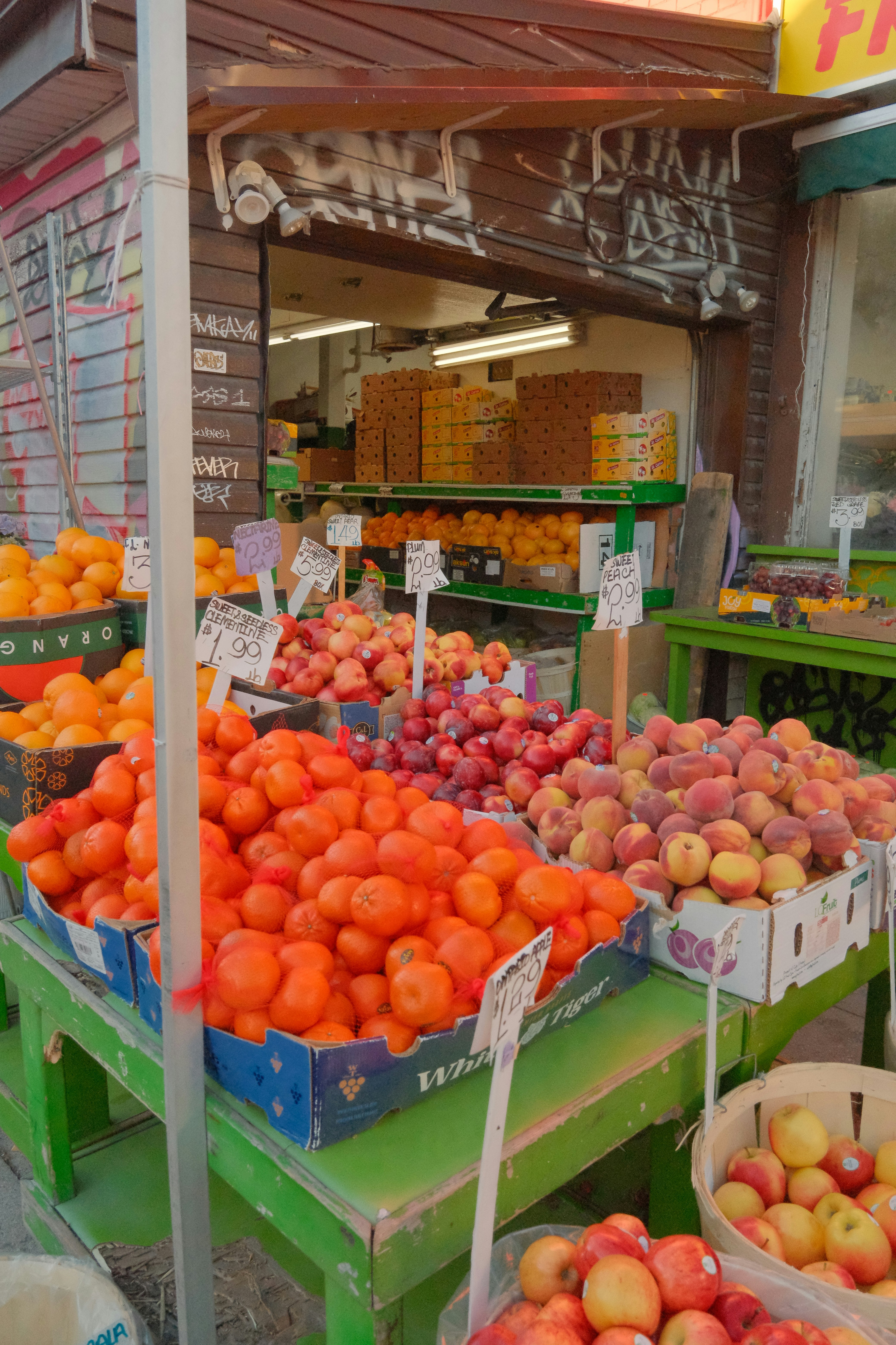 Market Stand Portrait: Vibrant Fruits Framing the Street Facade