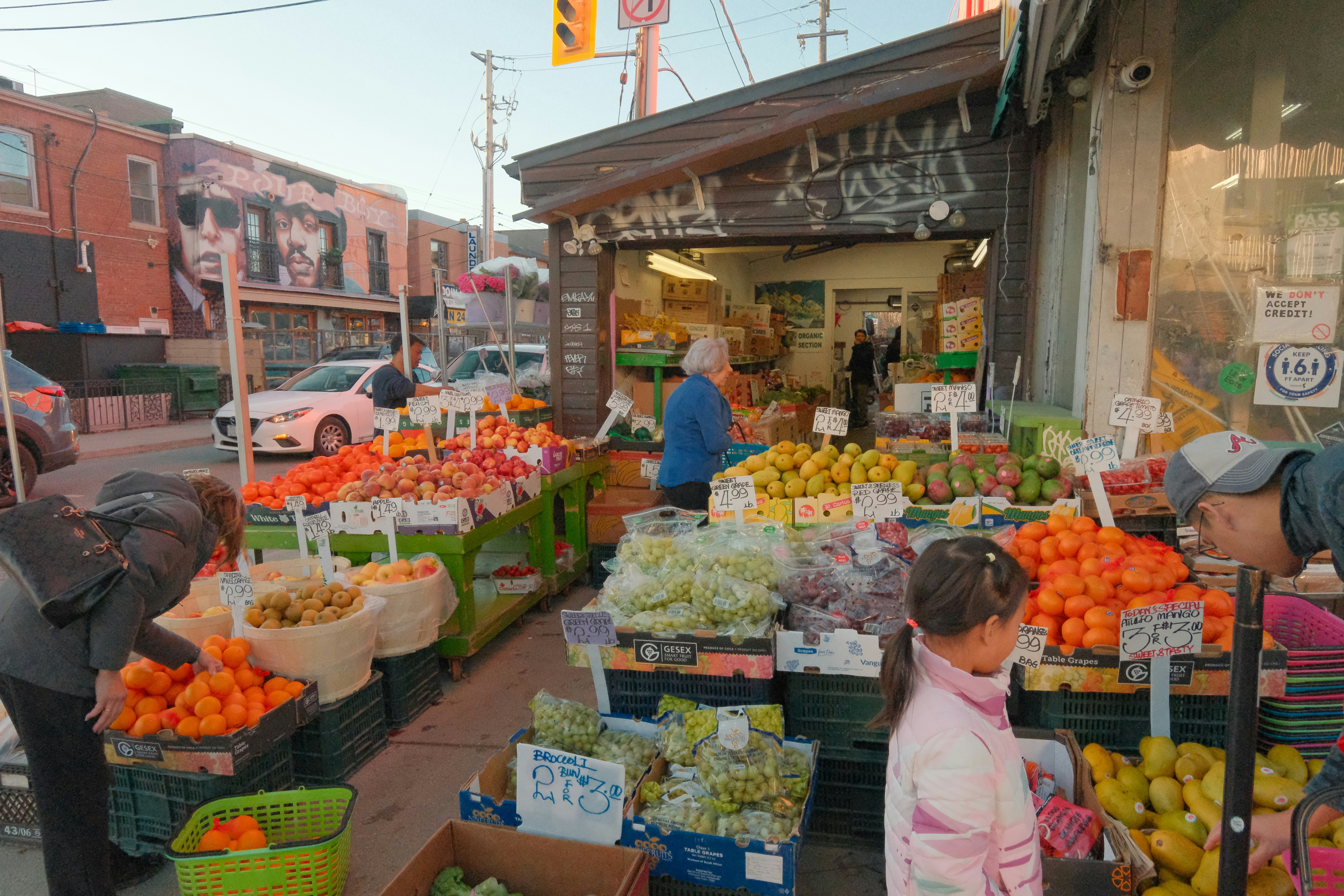 Market Street Portrait: Colorful Produce and Quiet Interaction