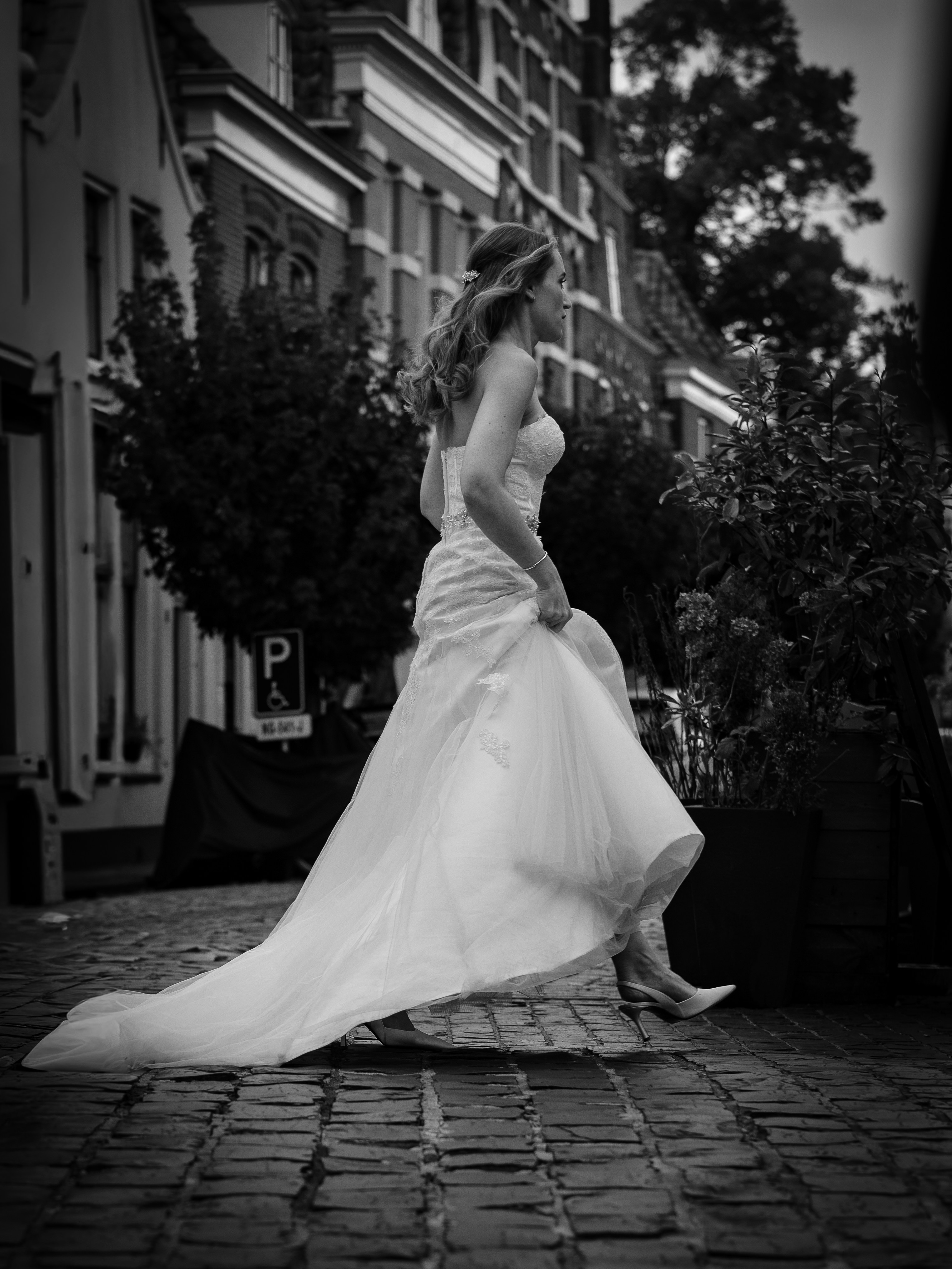 Wedding Walk: A Bride Draped in Silk Through a Cobblestone Street