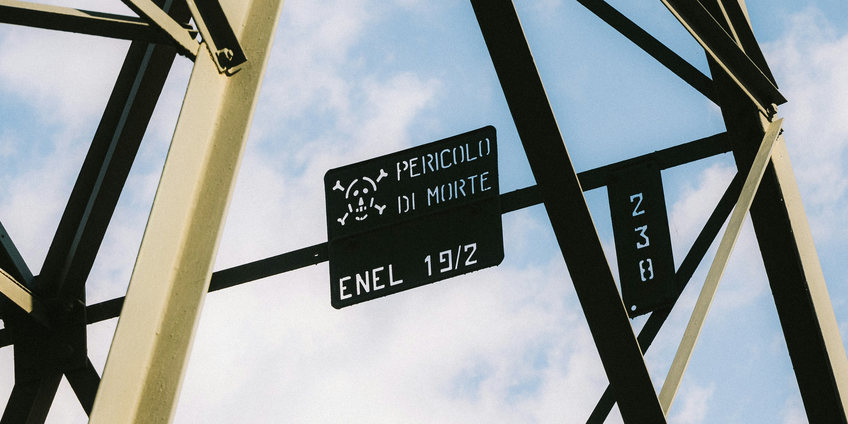 Industrial Signpost Against a Sky of Framing Steel
