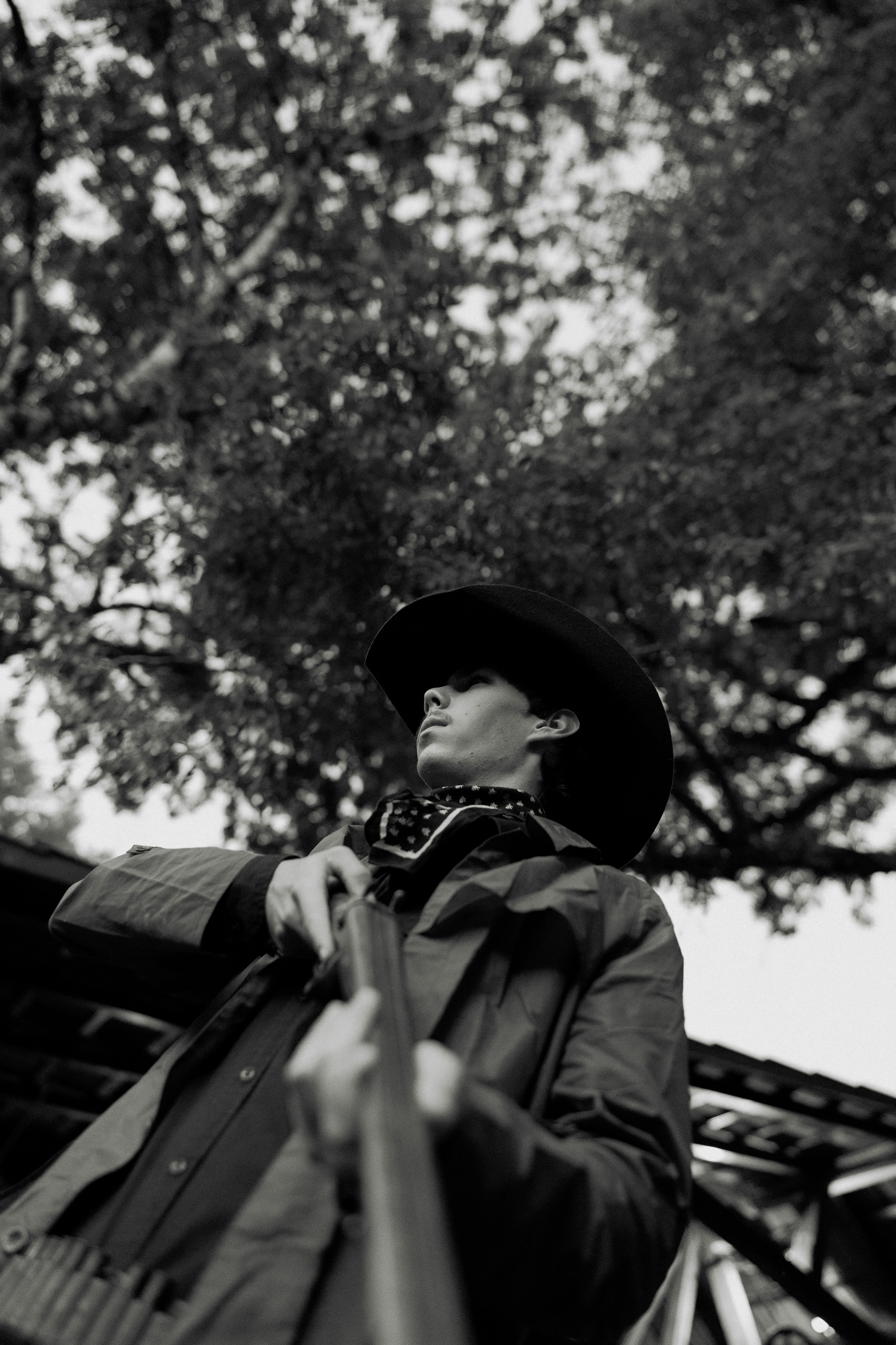 Low-Angle Portrait in Mono: A Cowboy’s Gaze Beneath the Hat