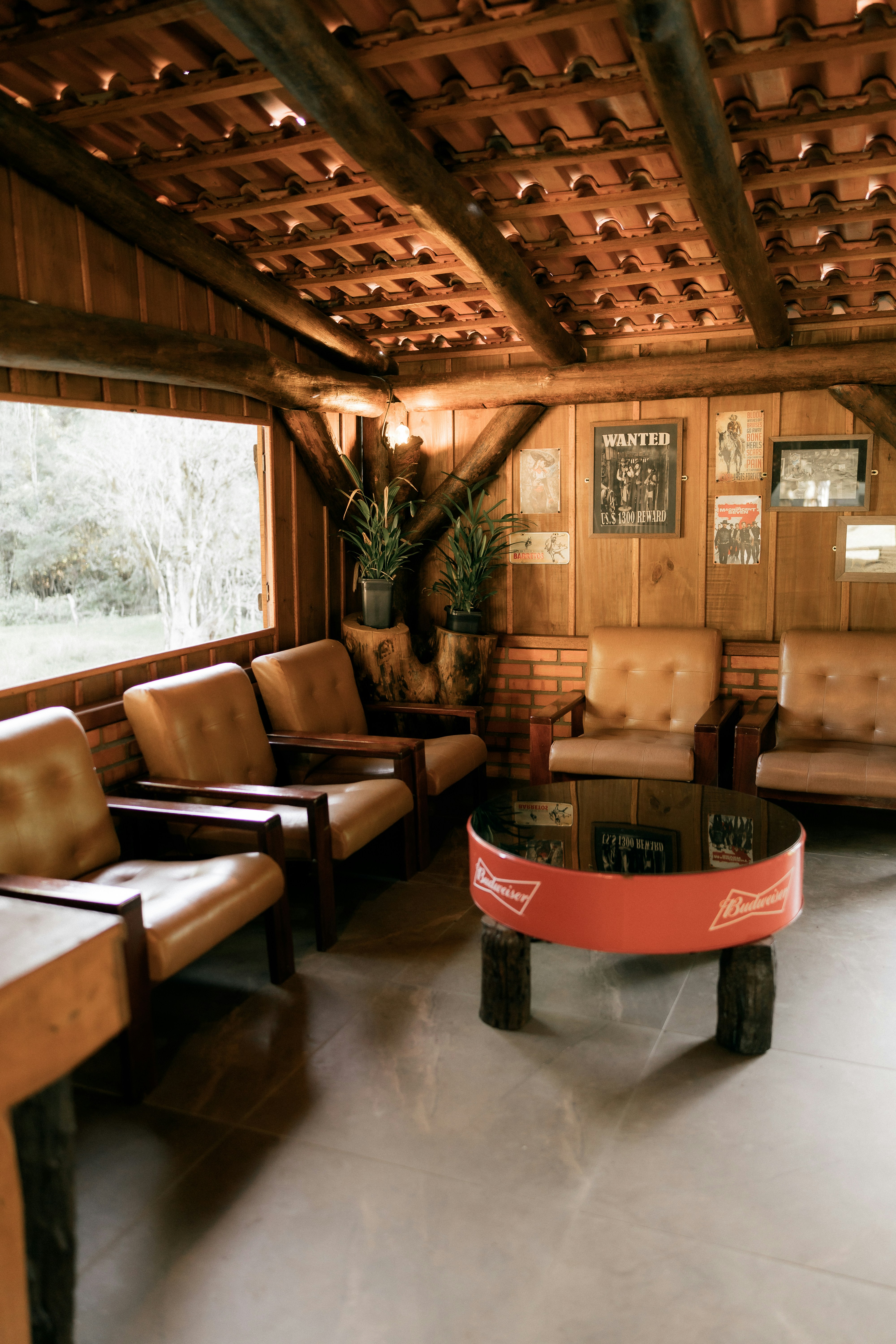 Rustic Lounge: Leather Chairs and Foosball Table in Warm-Toned Waiting Room