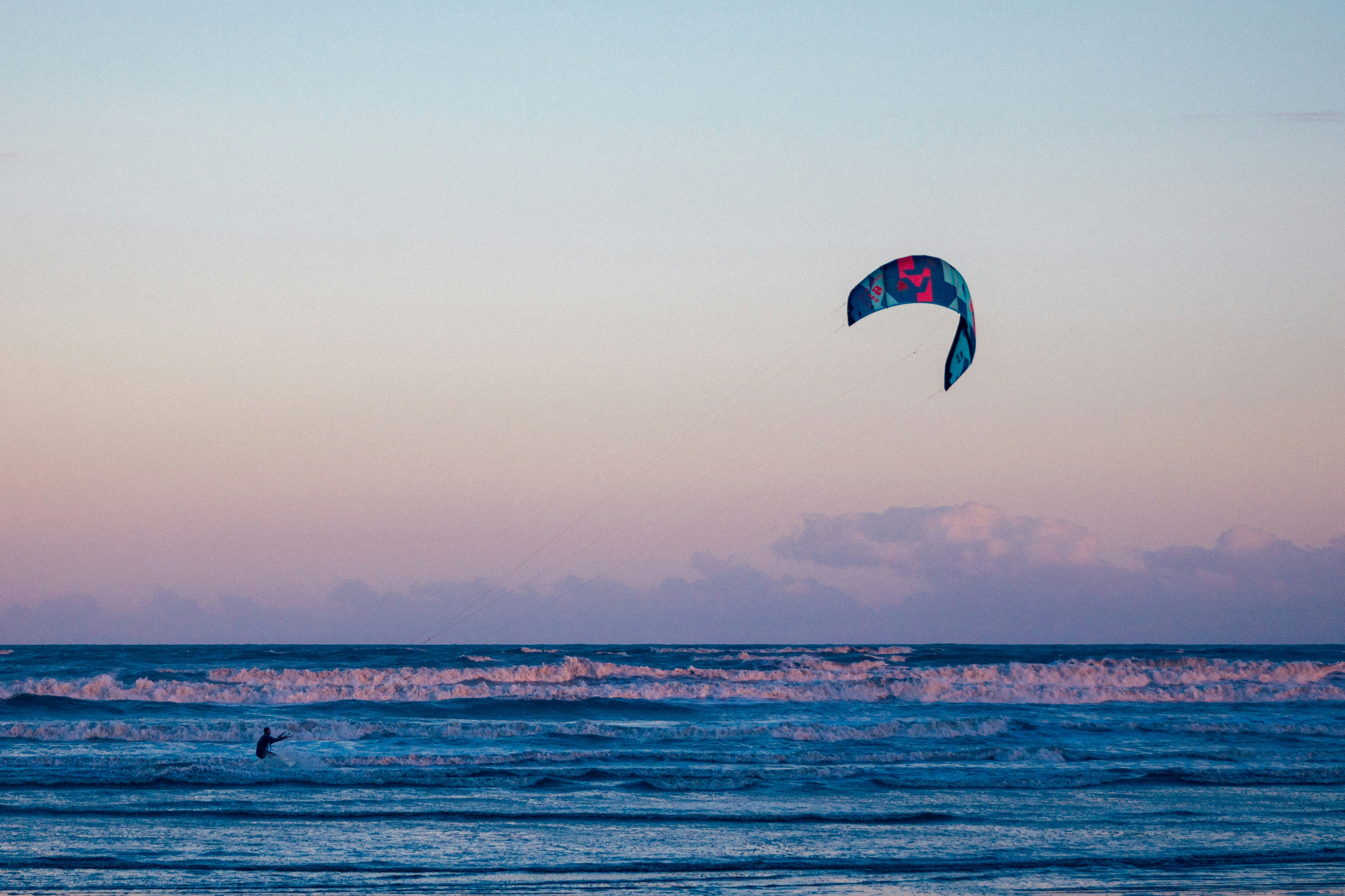 Kite Silhouette Above Rolling Twilight Waves