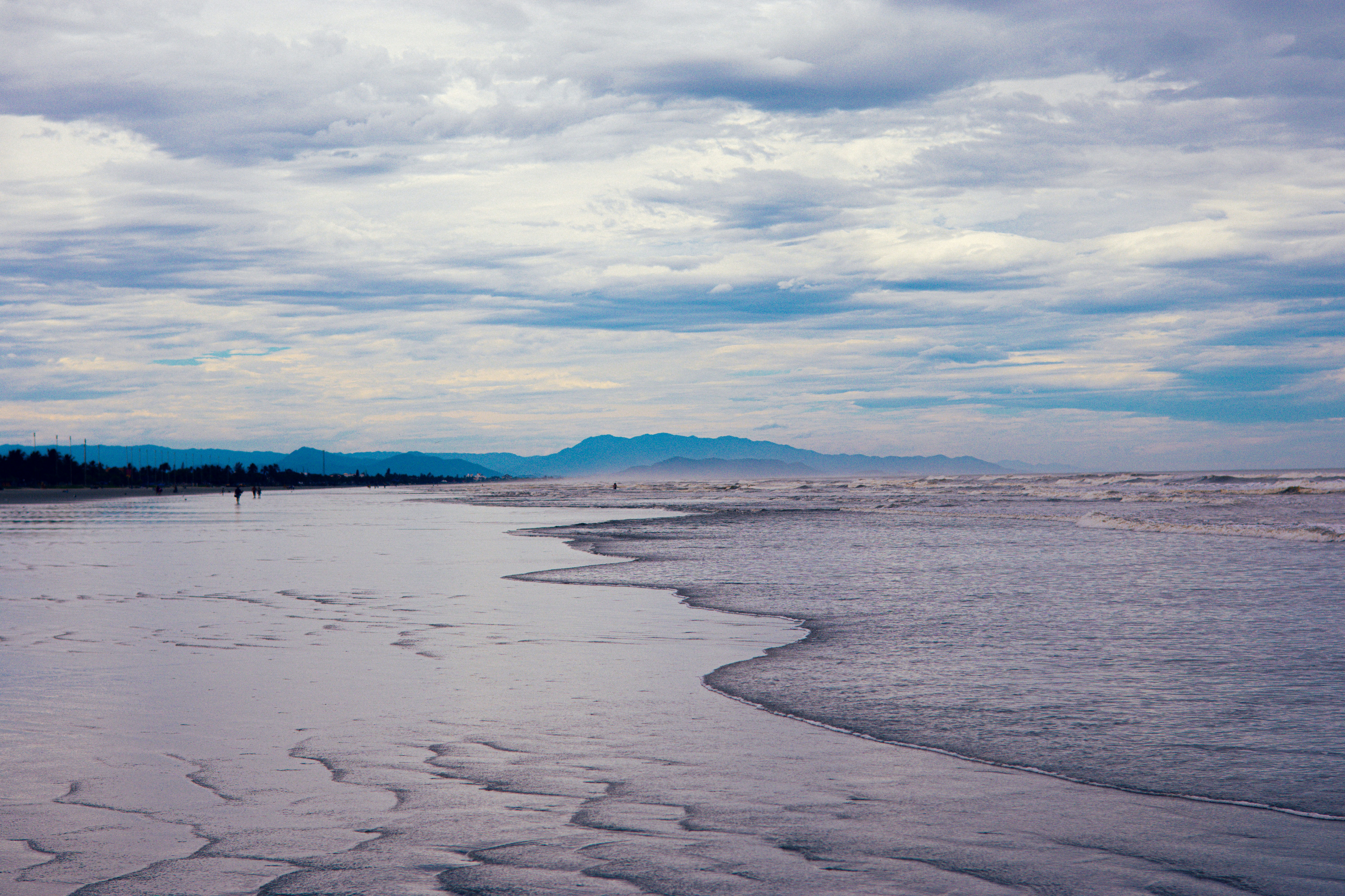 Coastal Confluence: Shoreline Curves Under A Quiet Sky