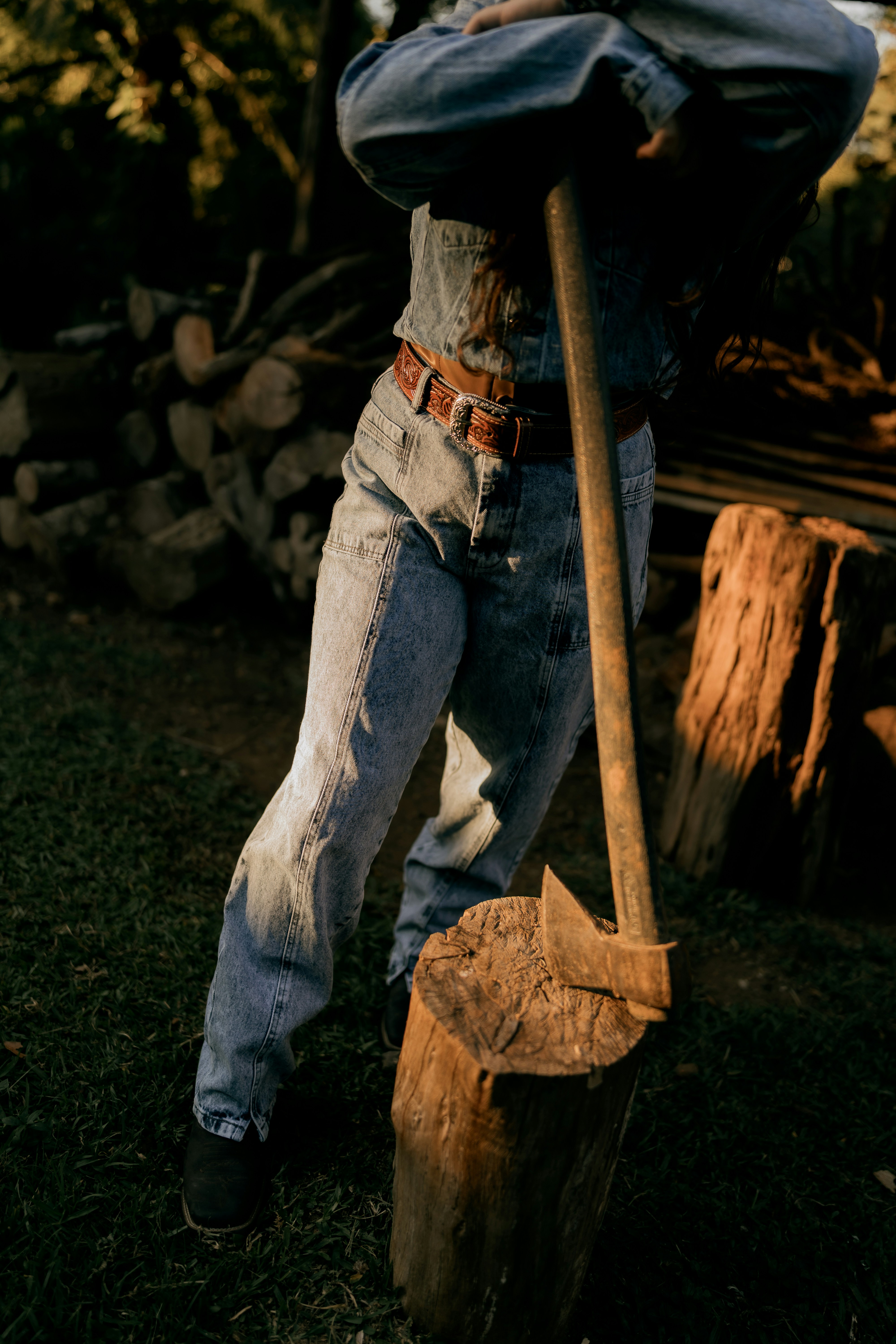 Entangled in the Woods: Axe Rest Between Leaning Jeans