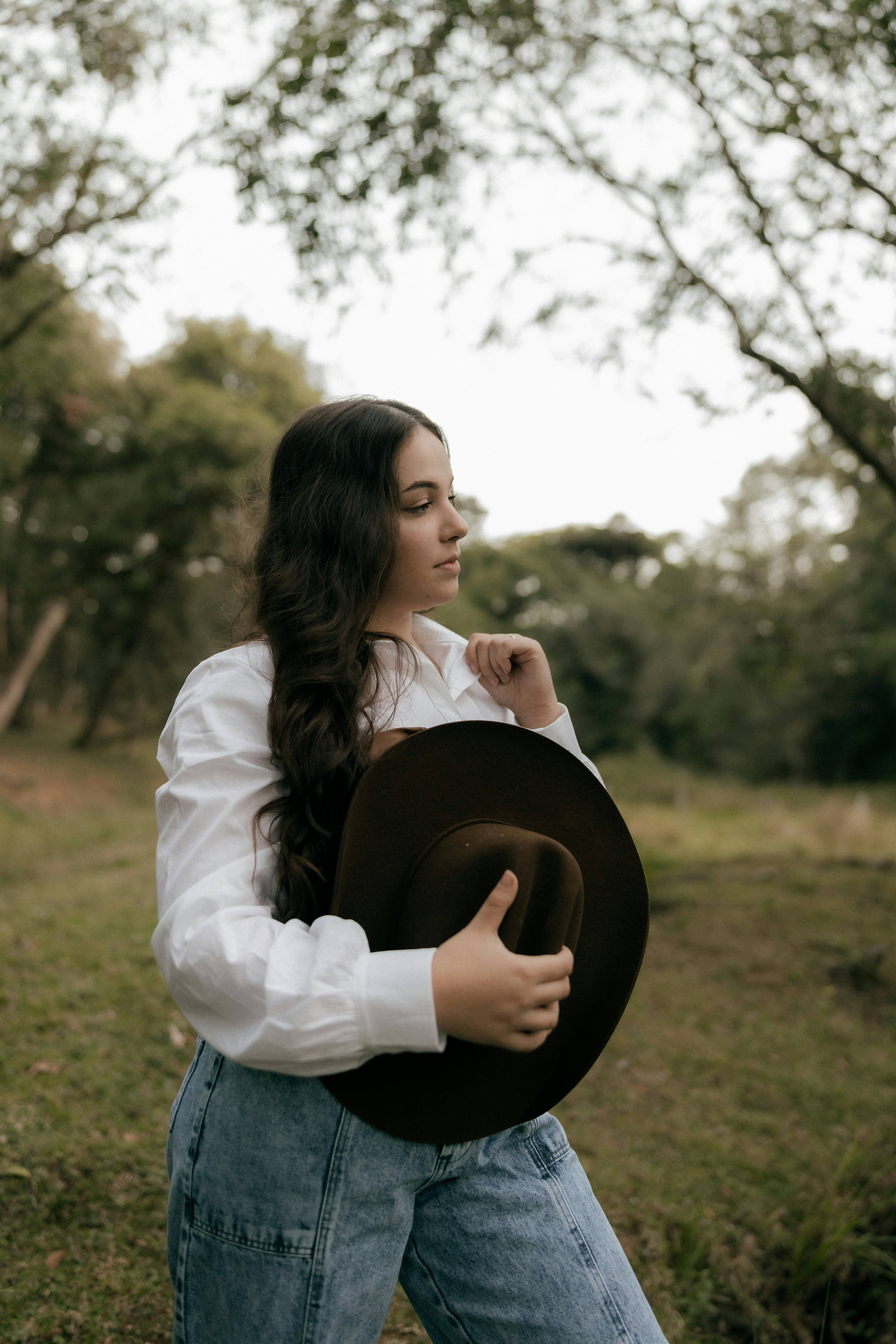 Flowing Quiet: A Portrait in Soft Light with a Wide-Brimd Moment