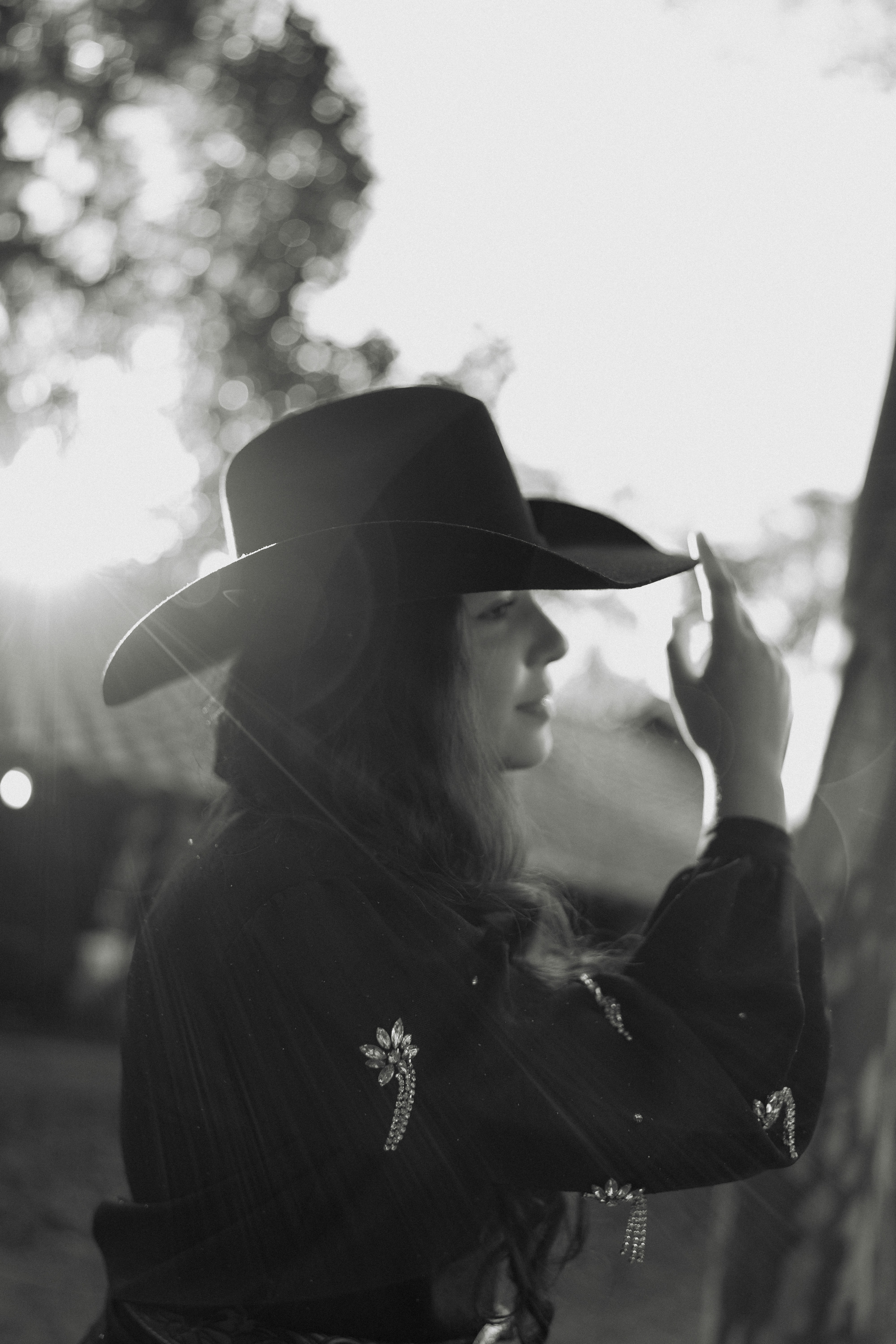 Silhouette in Soft Light: A Cowboy Hat and Quiet Gesture