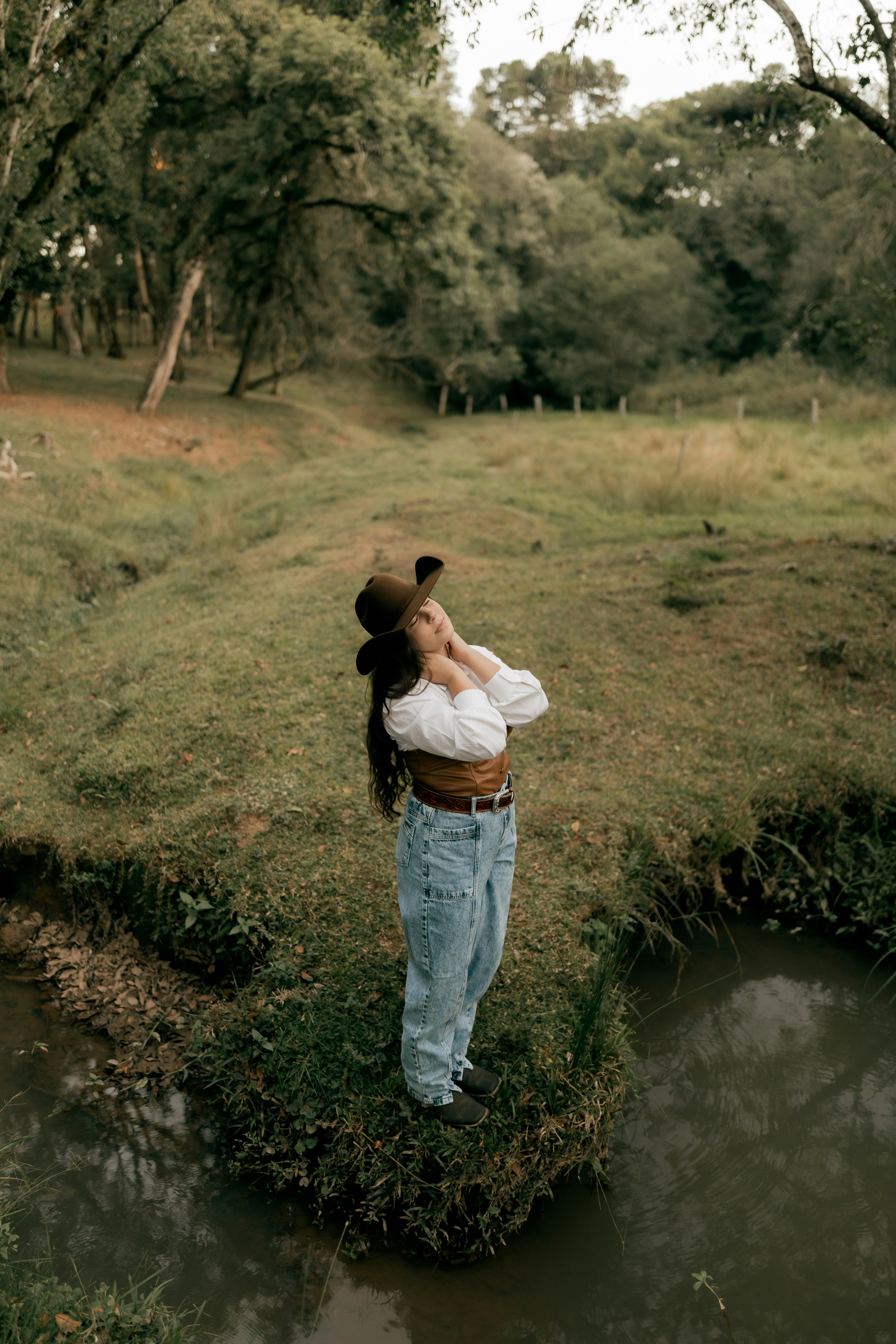 A Quiet Peak: Woman in a Wide Meadow by the Water