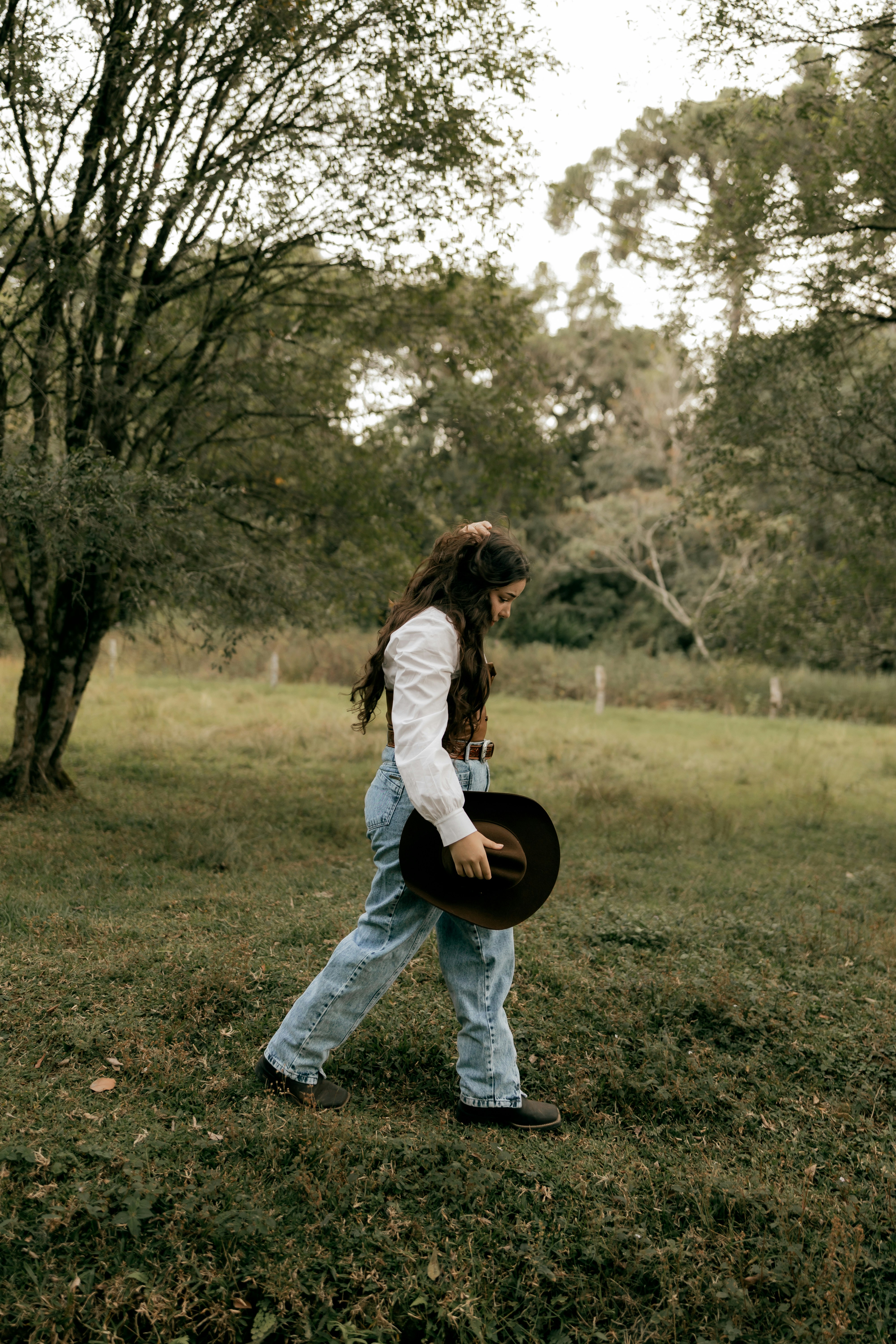 Field Walk: A Woman with Hat in a Quiet Meadow