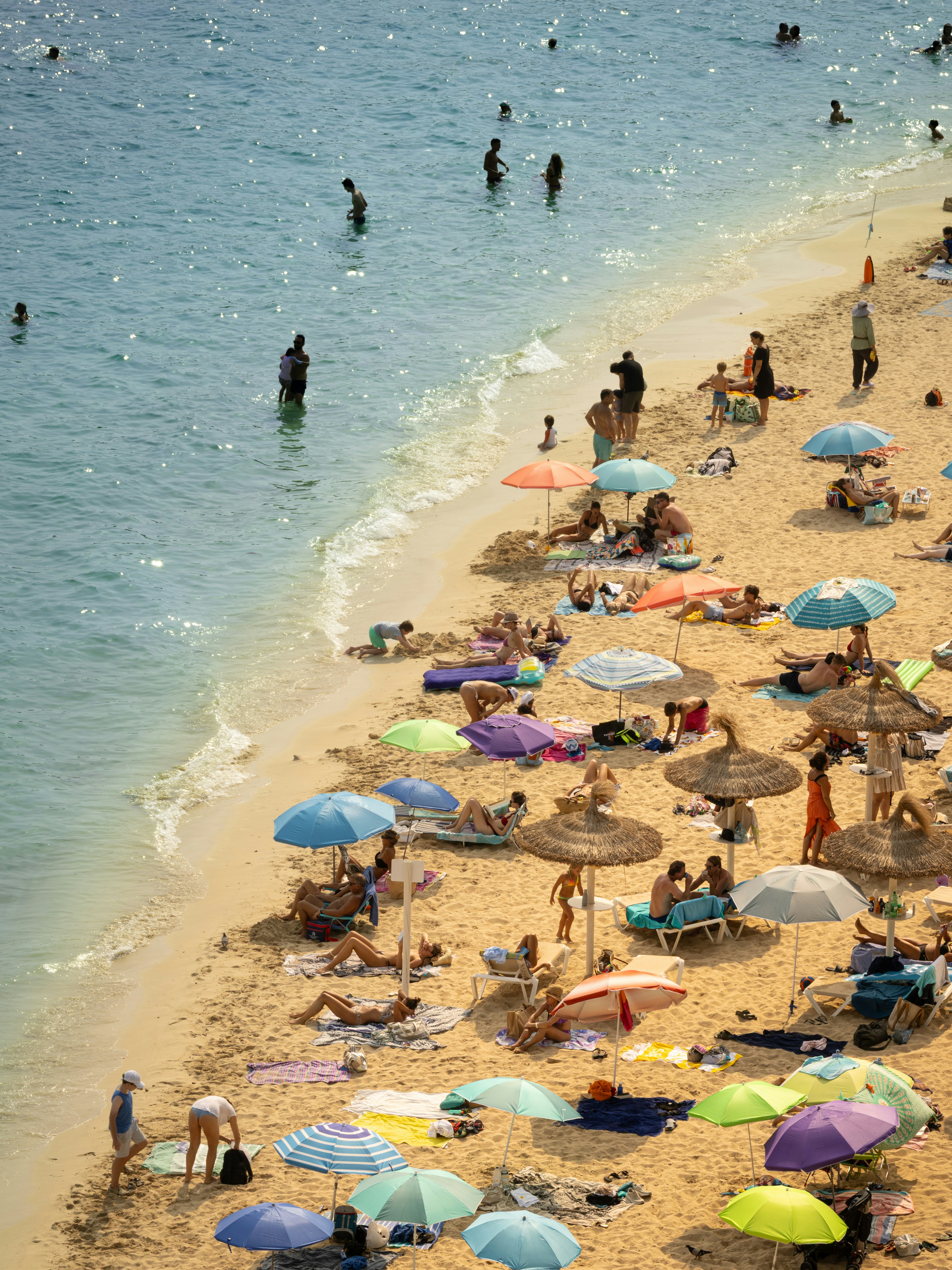 Sunlit Beach Mosaic: Umbrellas, Sand, and Sea