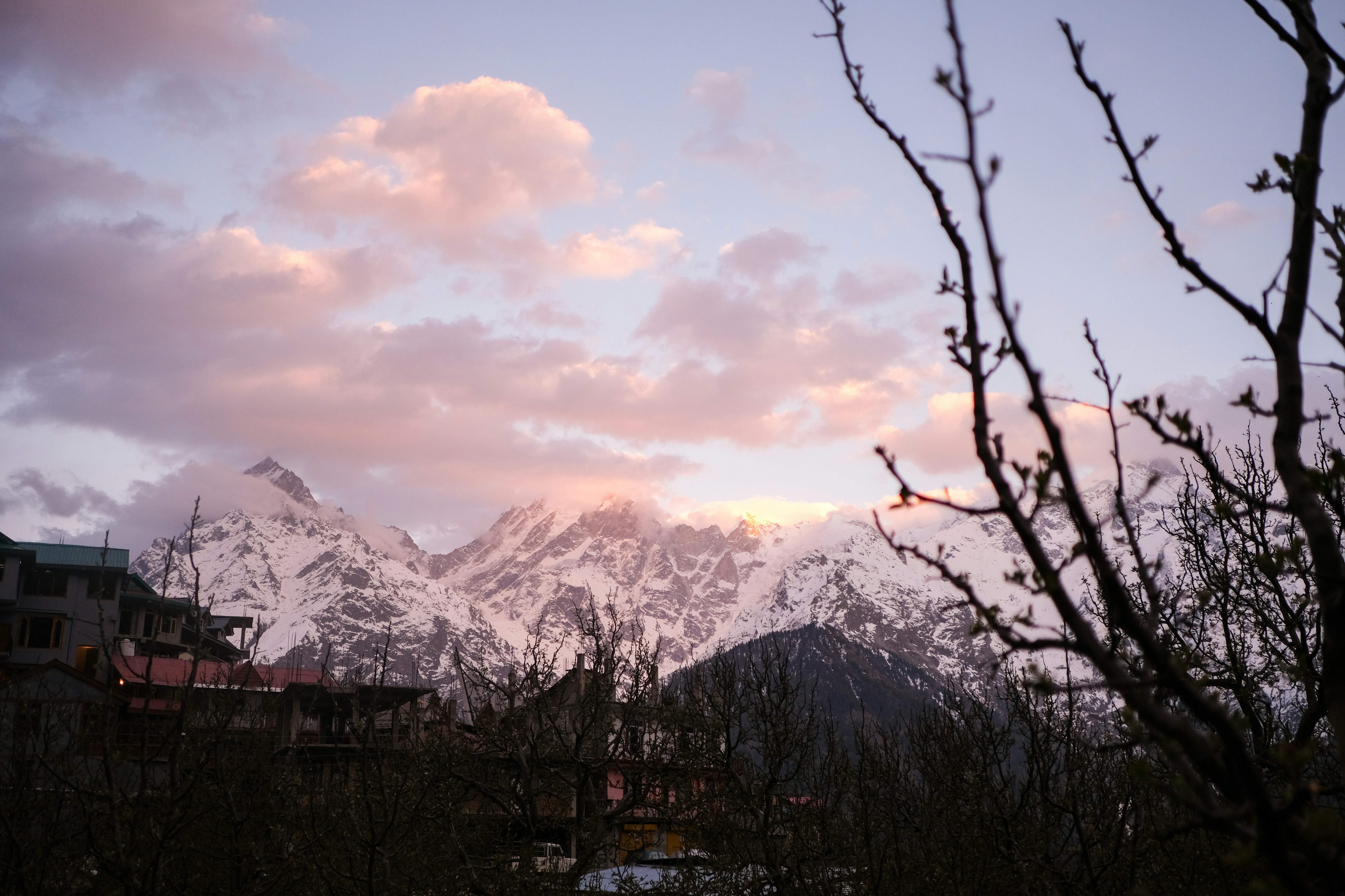 Dawn Over Snow-Capped Peaks Behind a Quiet Town