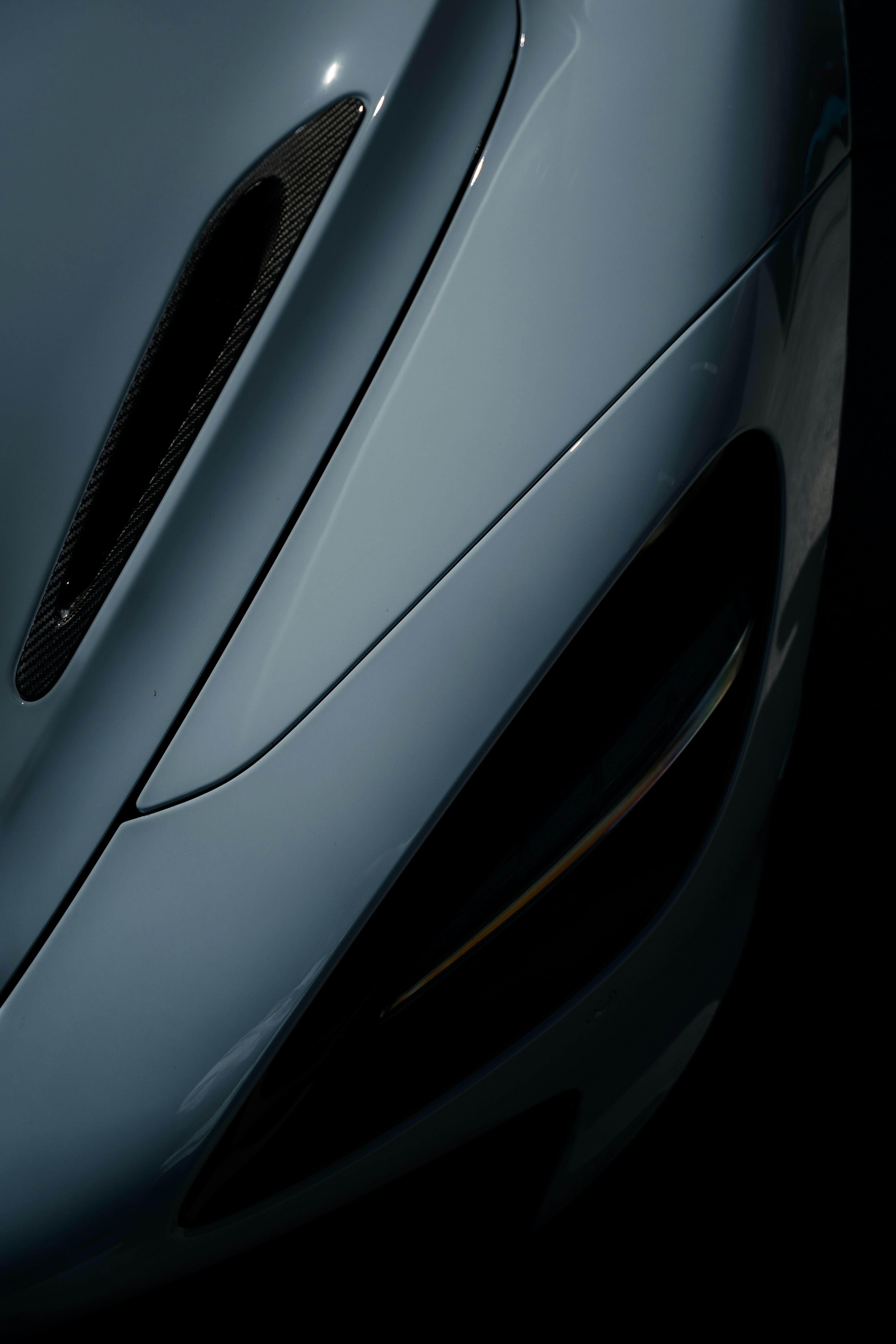 Blue Car Silhouette: Curves and Vents in Quiet Light