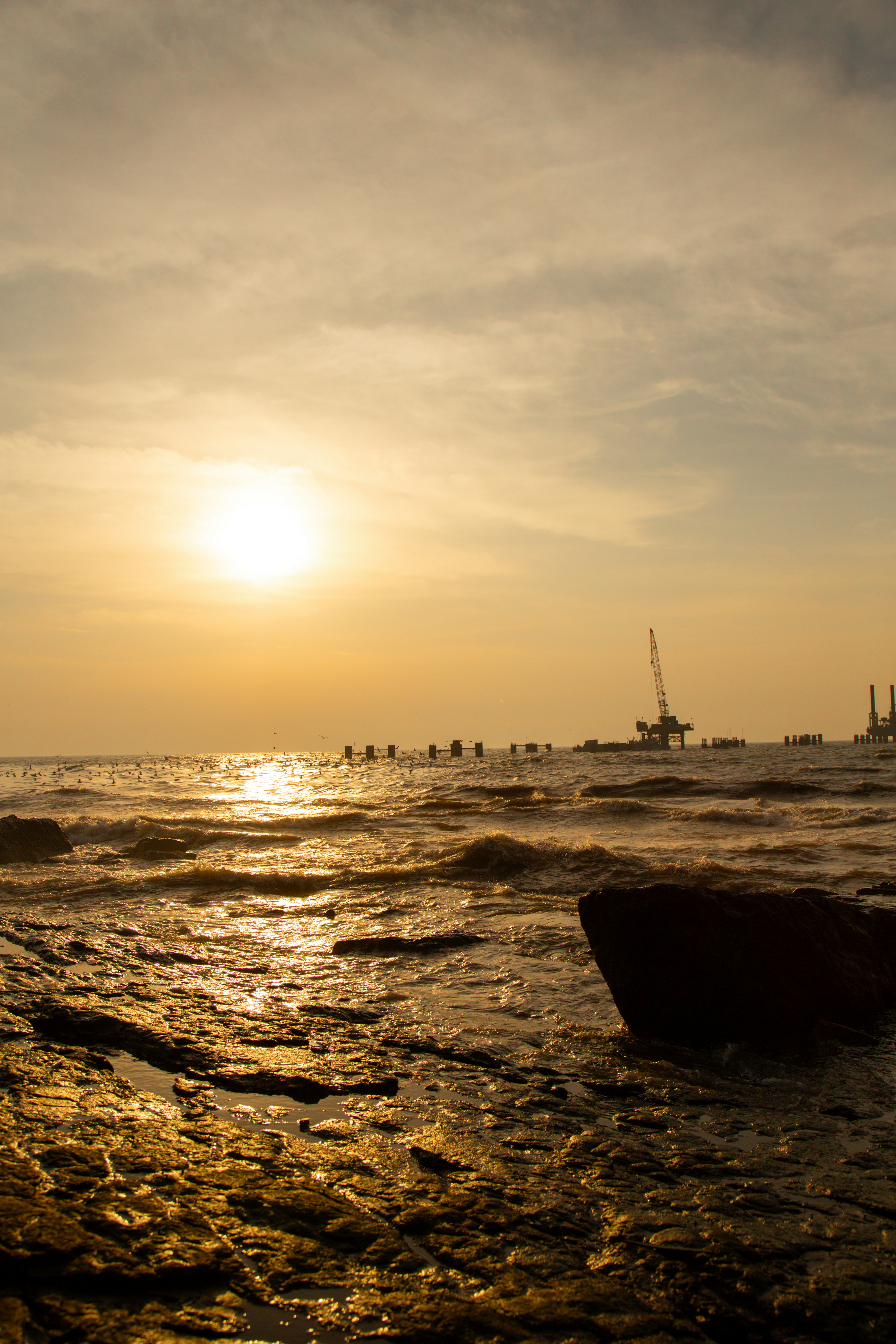 Sunlit Hull: A Quiet Coastal Moment by the Offshore Rig