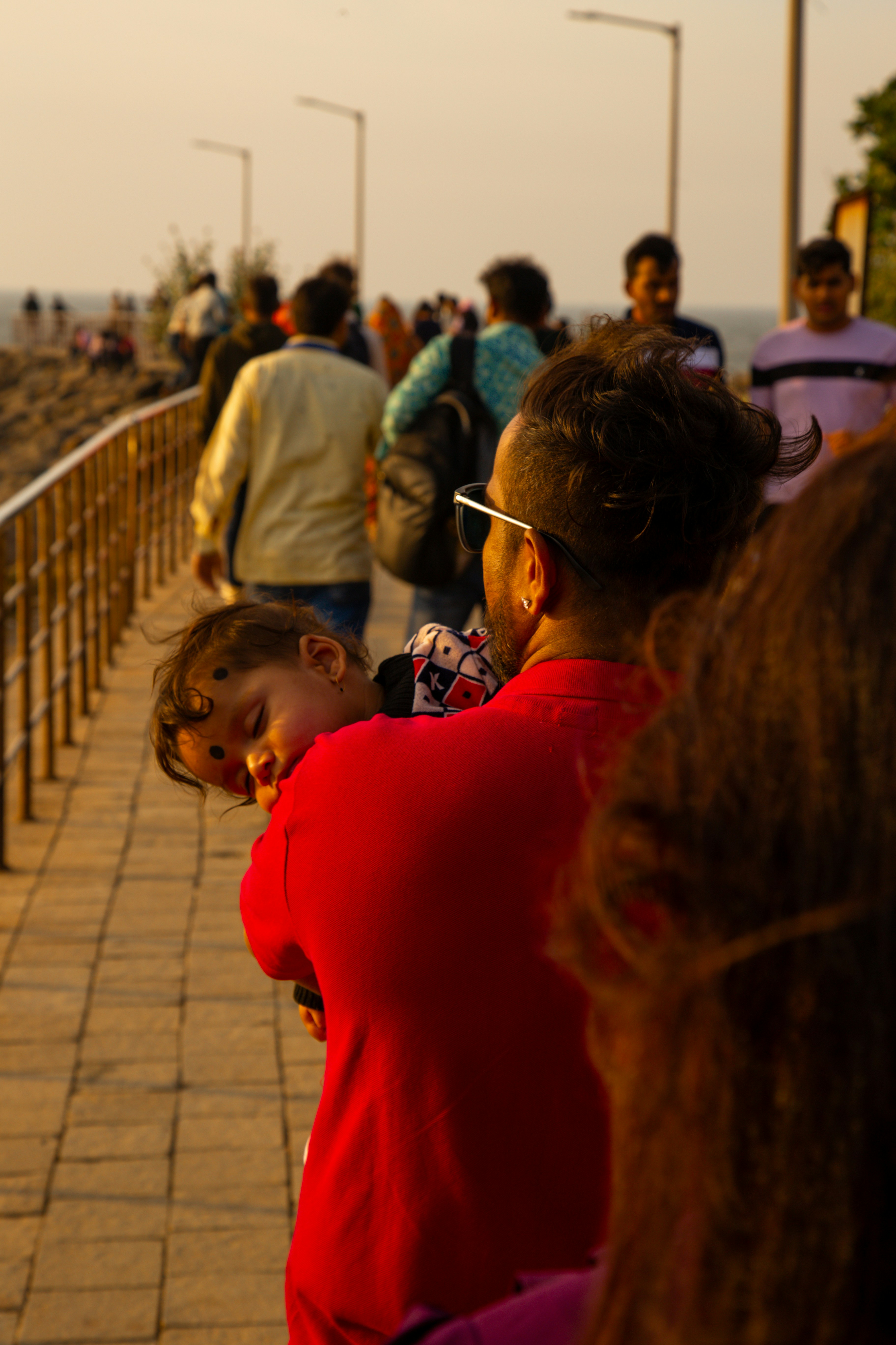Carried by a Warm Tide: A Father and Child Share a Quiet Moment on the Boardwalk