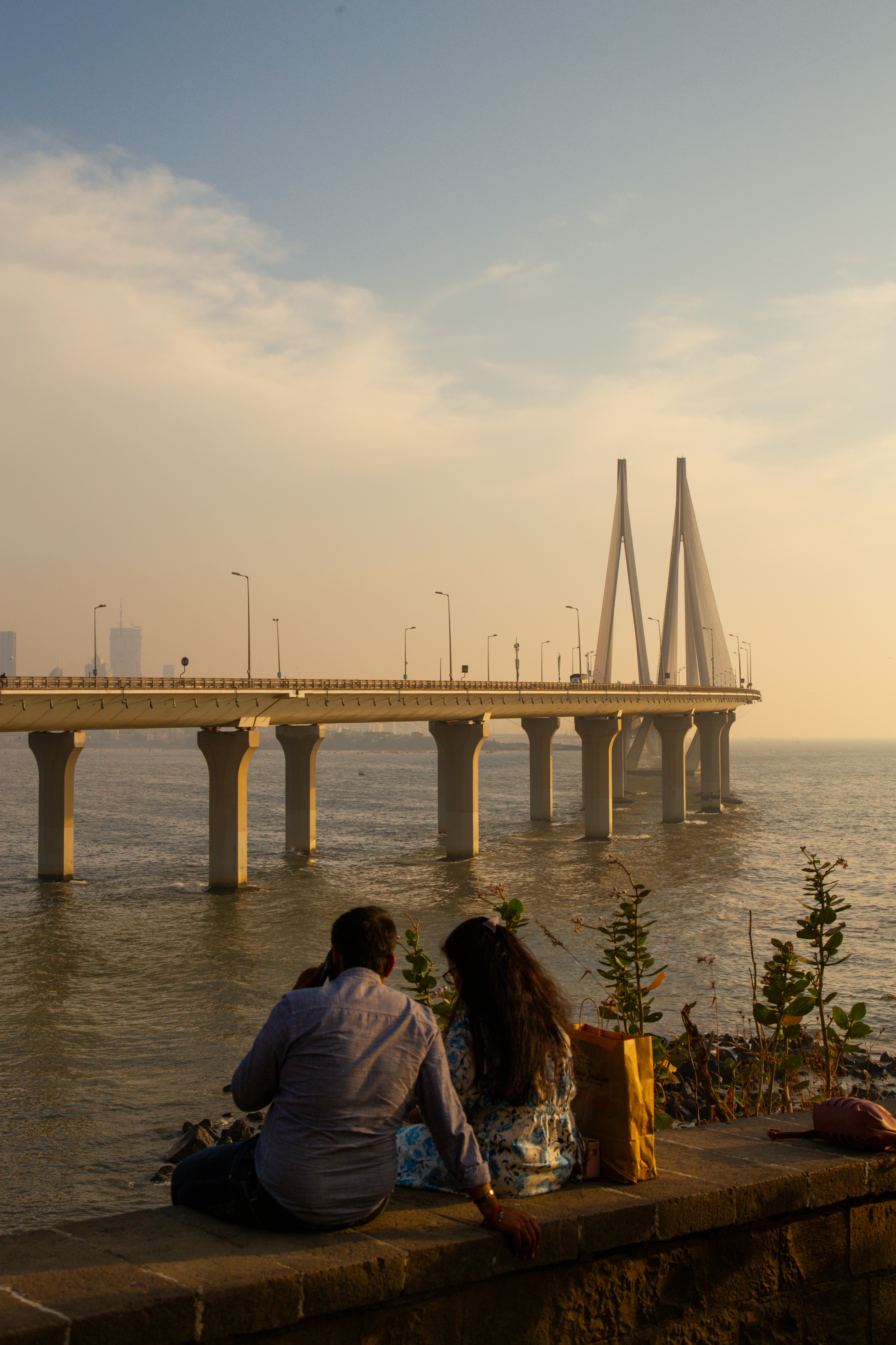 Late Day Couple on the Waterfront with Cable-Stayed Bridge