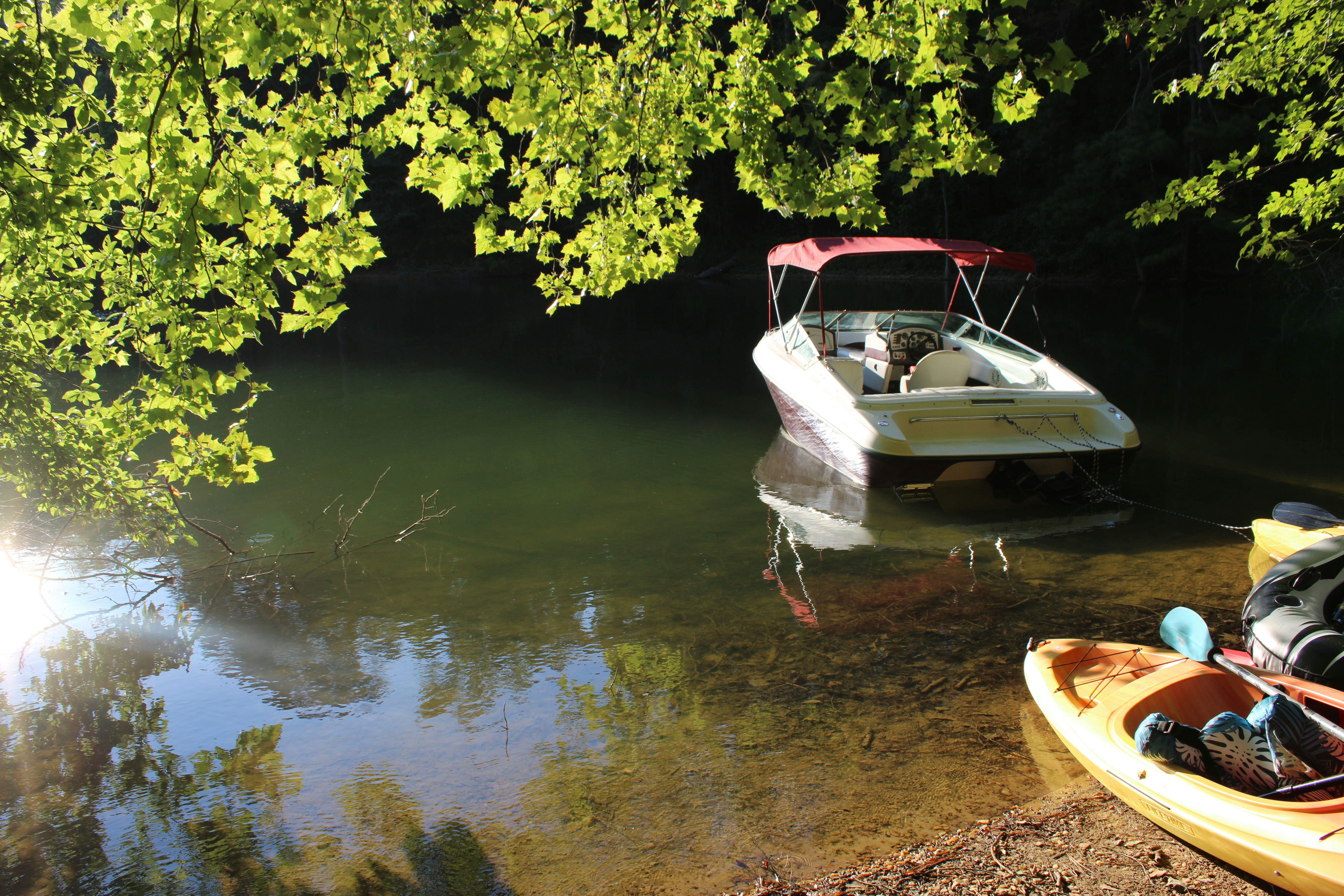 Sunlit Marina Stillness: A Pair of Boats by Clear Water