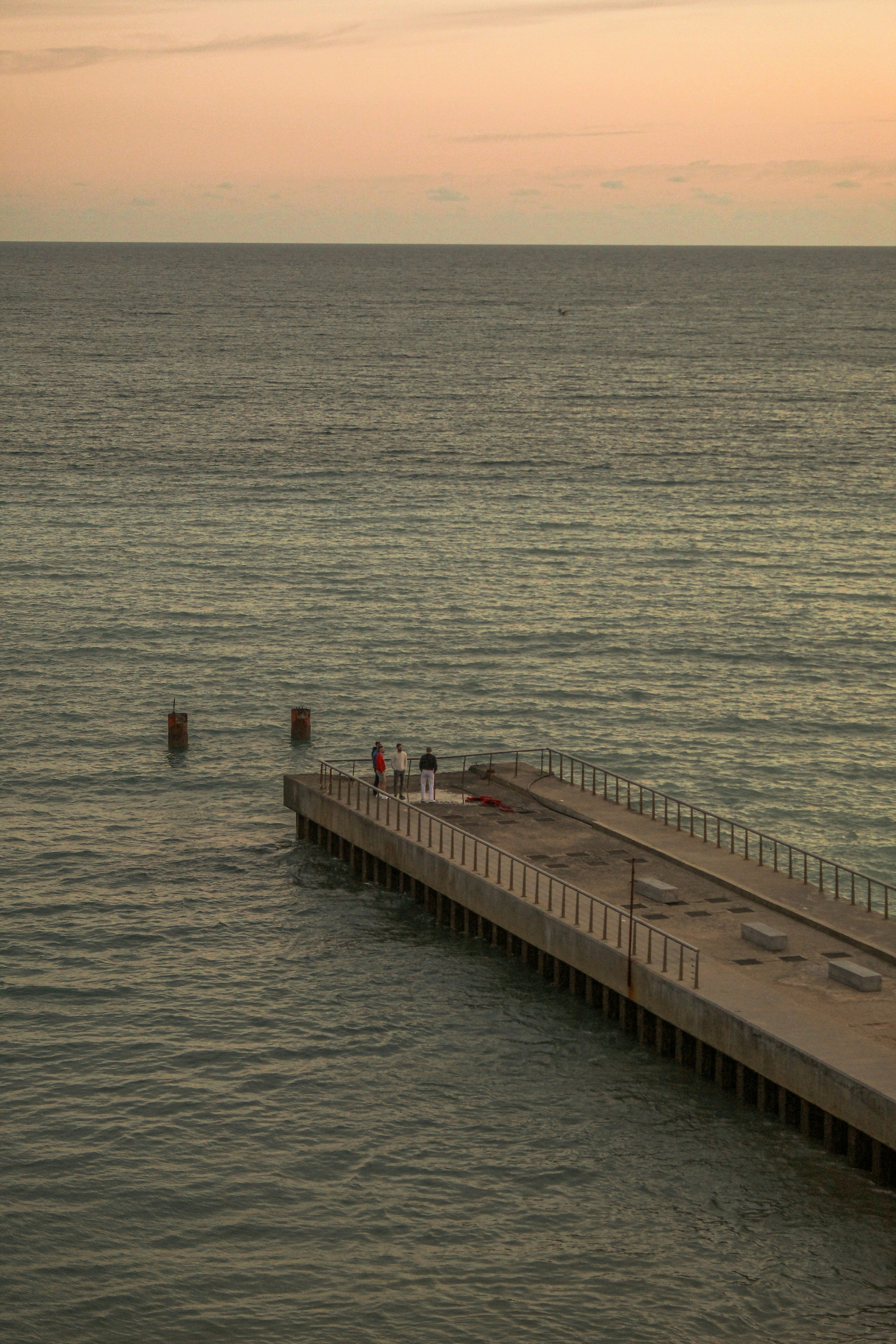 Pierside at Dusk: A Quiet Gather on the Ocean Break