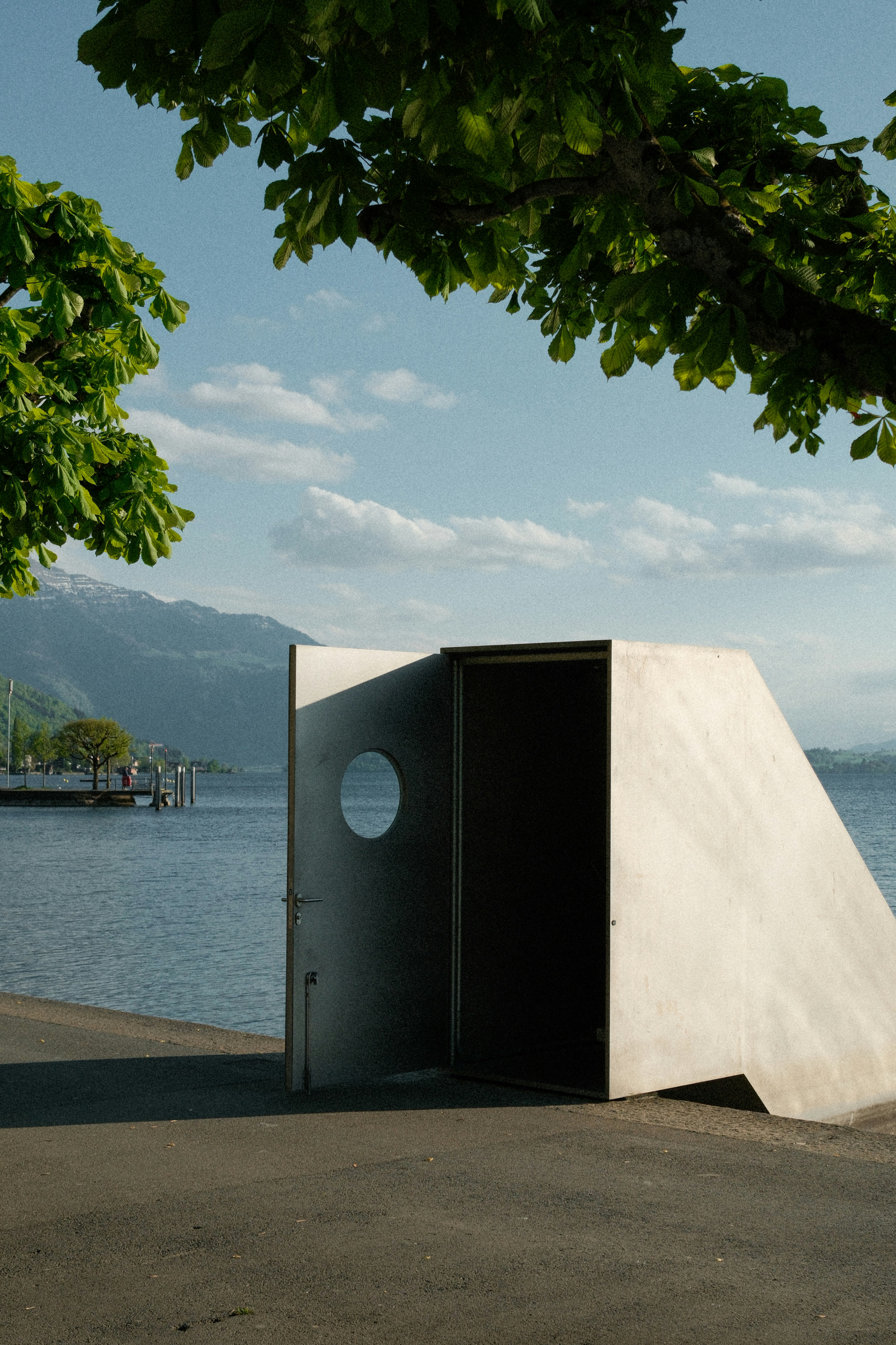 Concrete Pier Doorway Framed by Green Canopy at Lakeside