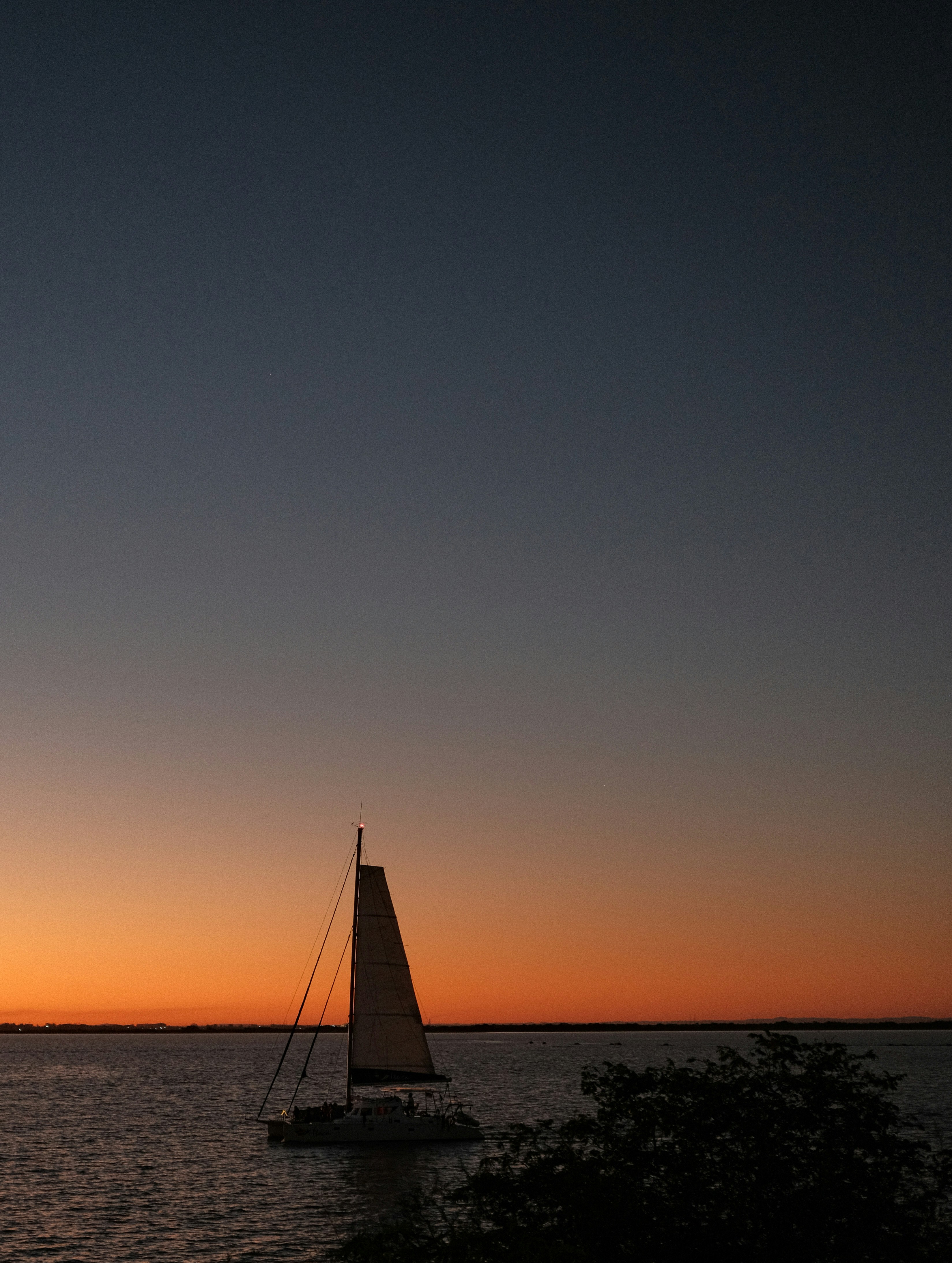 Sailboat at Dusk: A Quiet Horizon on Still Waters