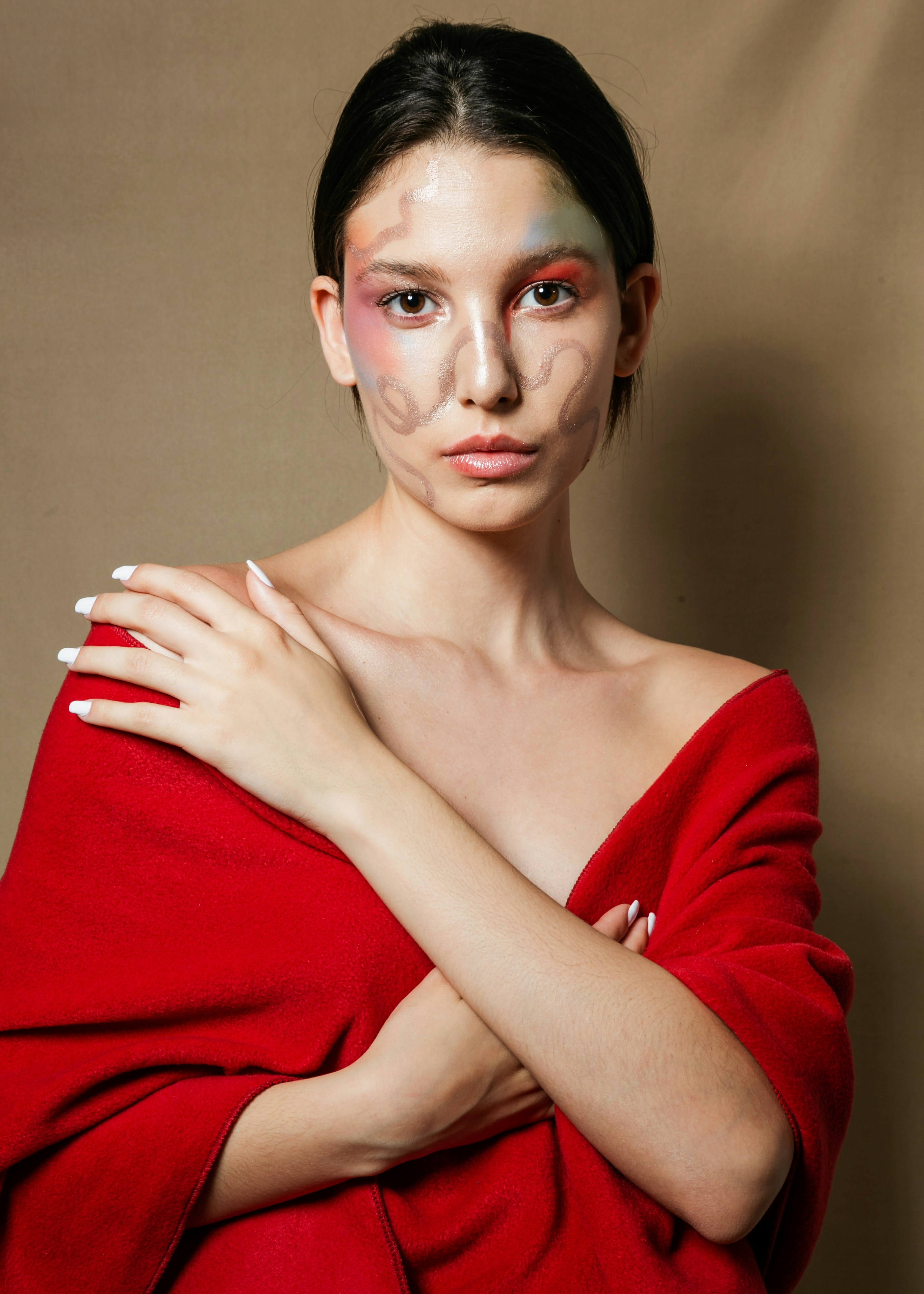Red-wrapped everyman: a poised gaze under painted light