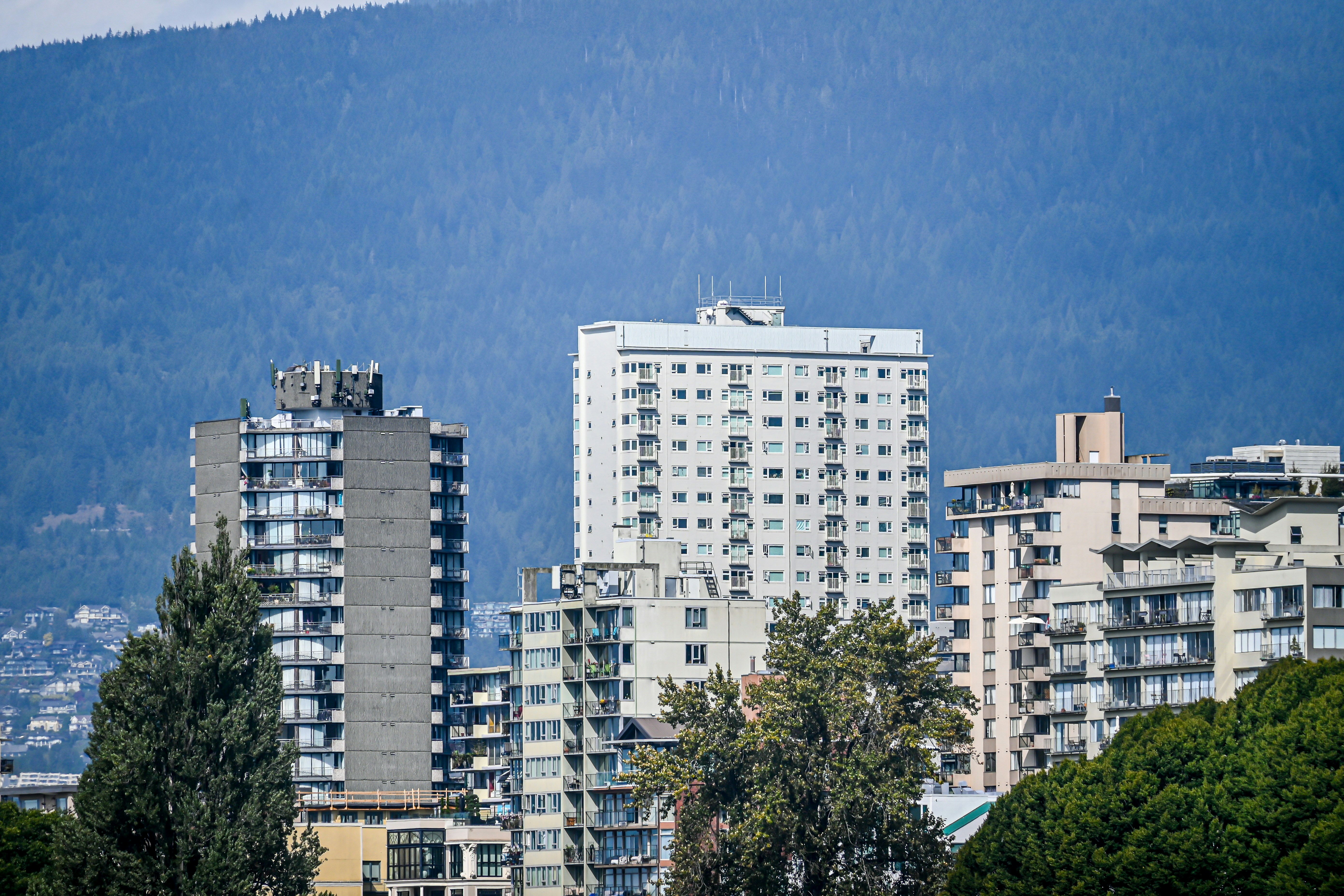 Concrete Horizon: High-Rrise Chorus Against a Mountain Backdrop