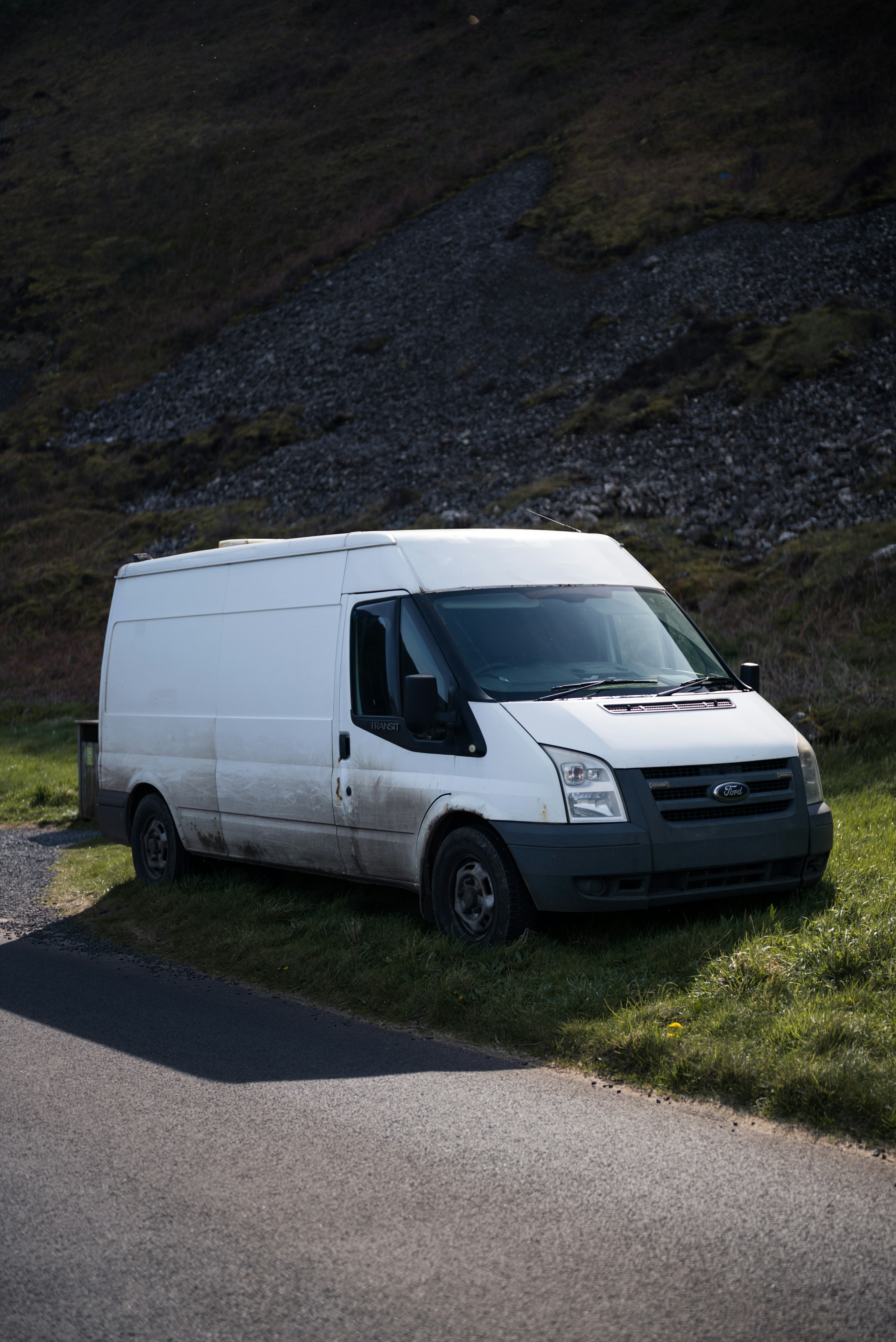 White Van at the Edge of a Winding Road