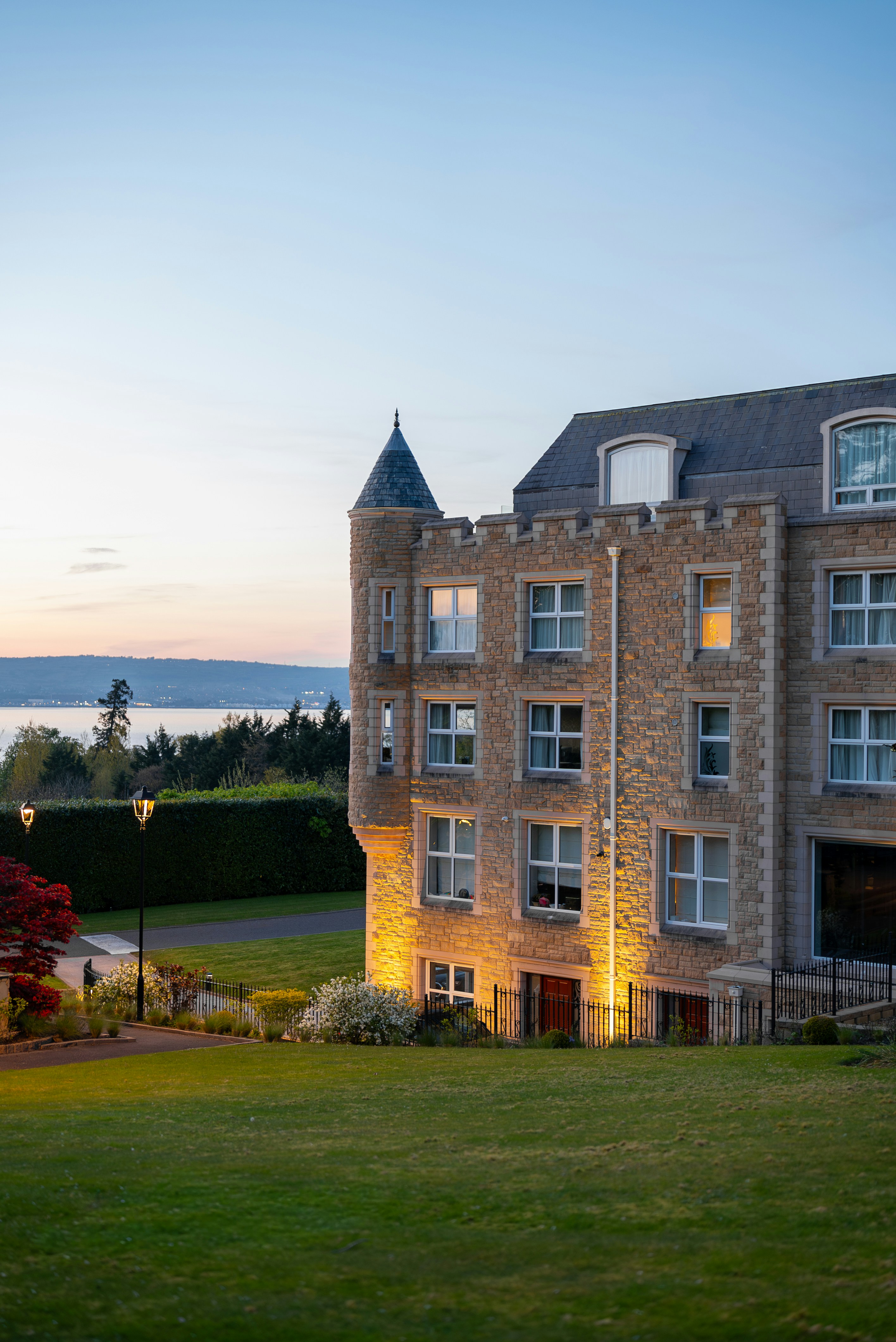 Stone Villa at Dusk: Warm Light on the Tiered Windows