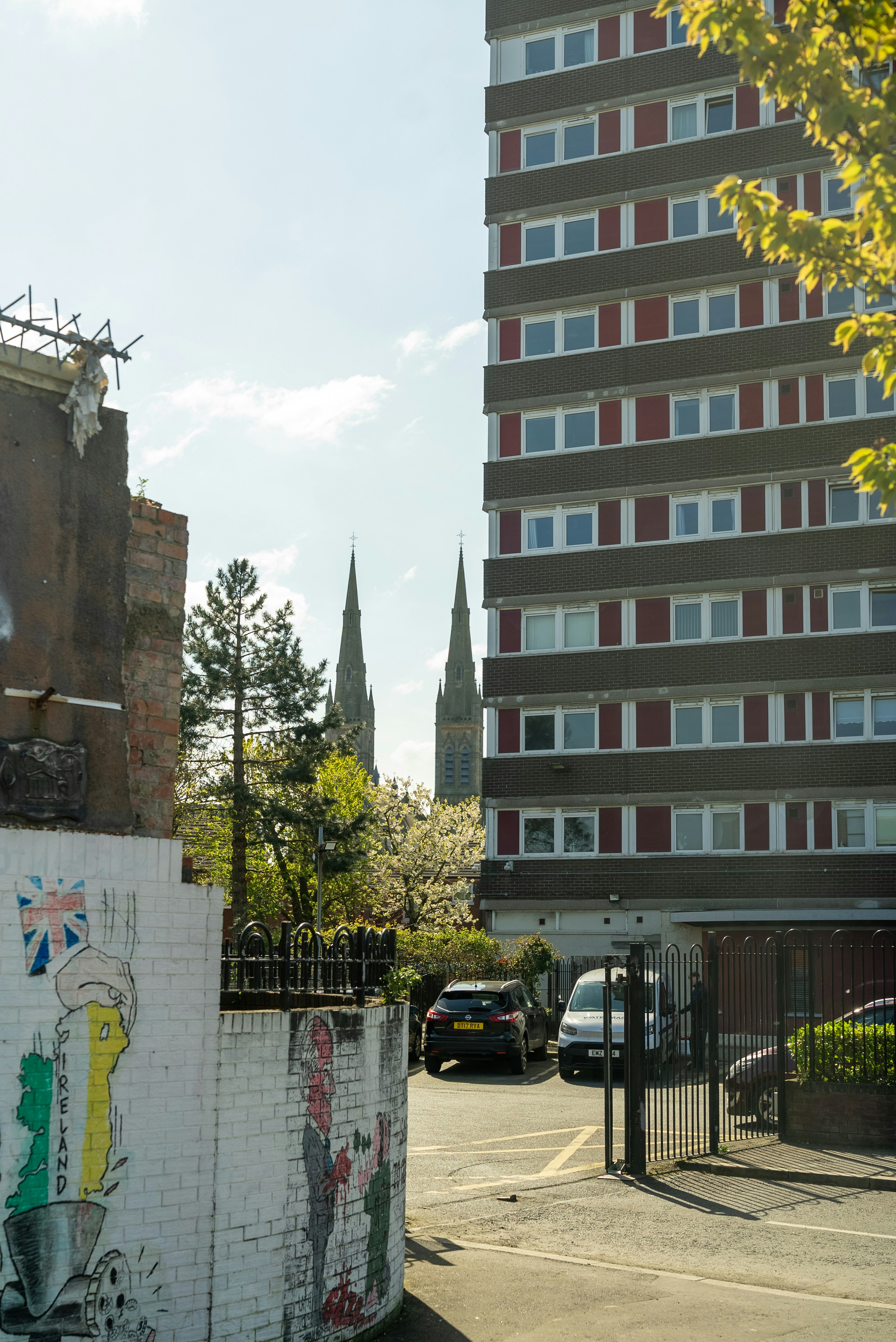 Urban Curtain of Towers: A Narrow Street Framed by a Red-Brick High-Rise