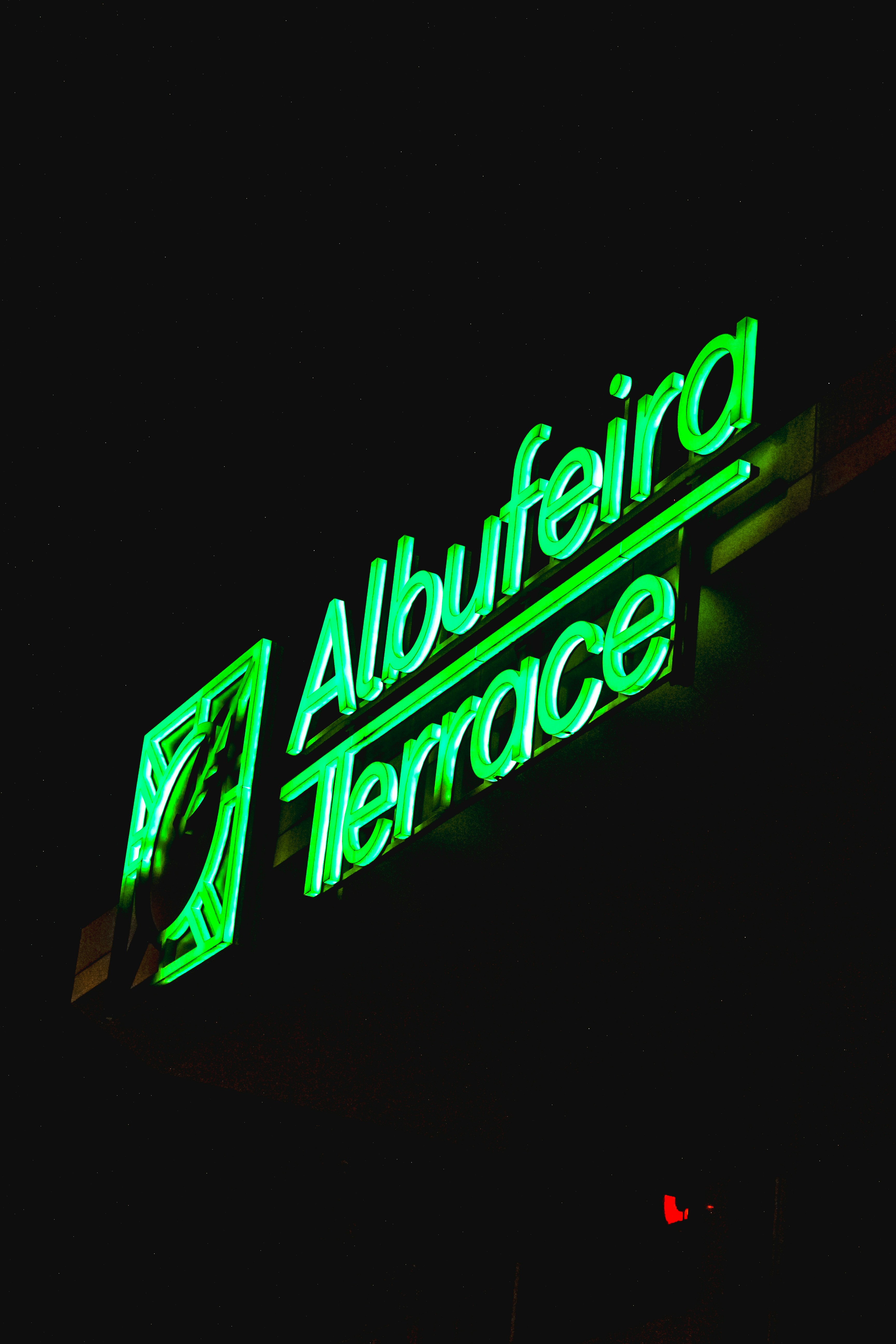 Neon Terrace: Night Sign Glowing Over Albufeira