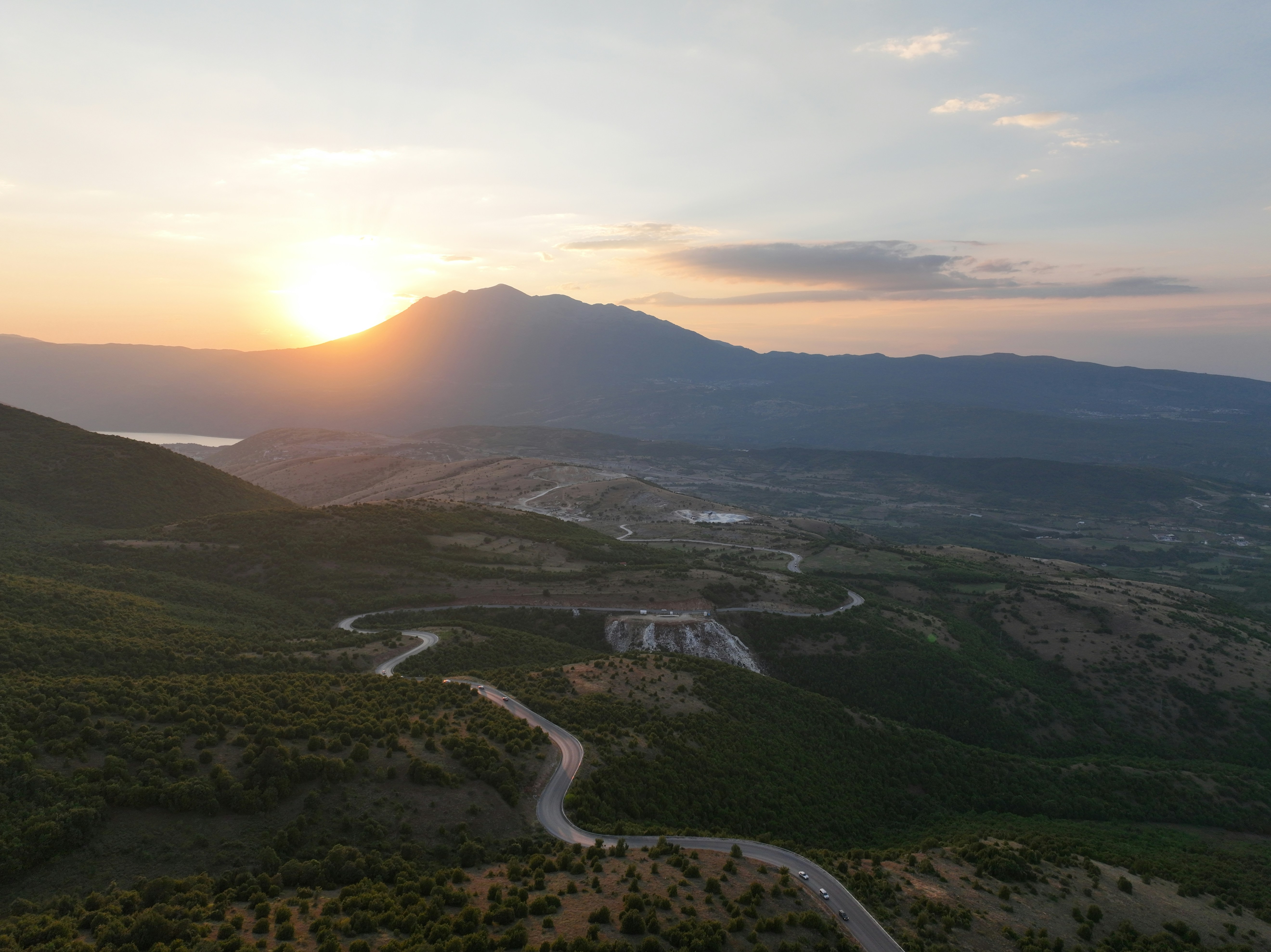 Sunlit Summit Over Rolling Green Ridges