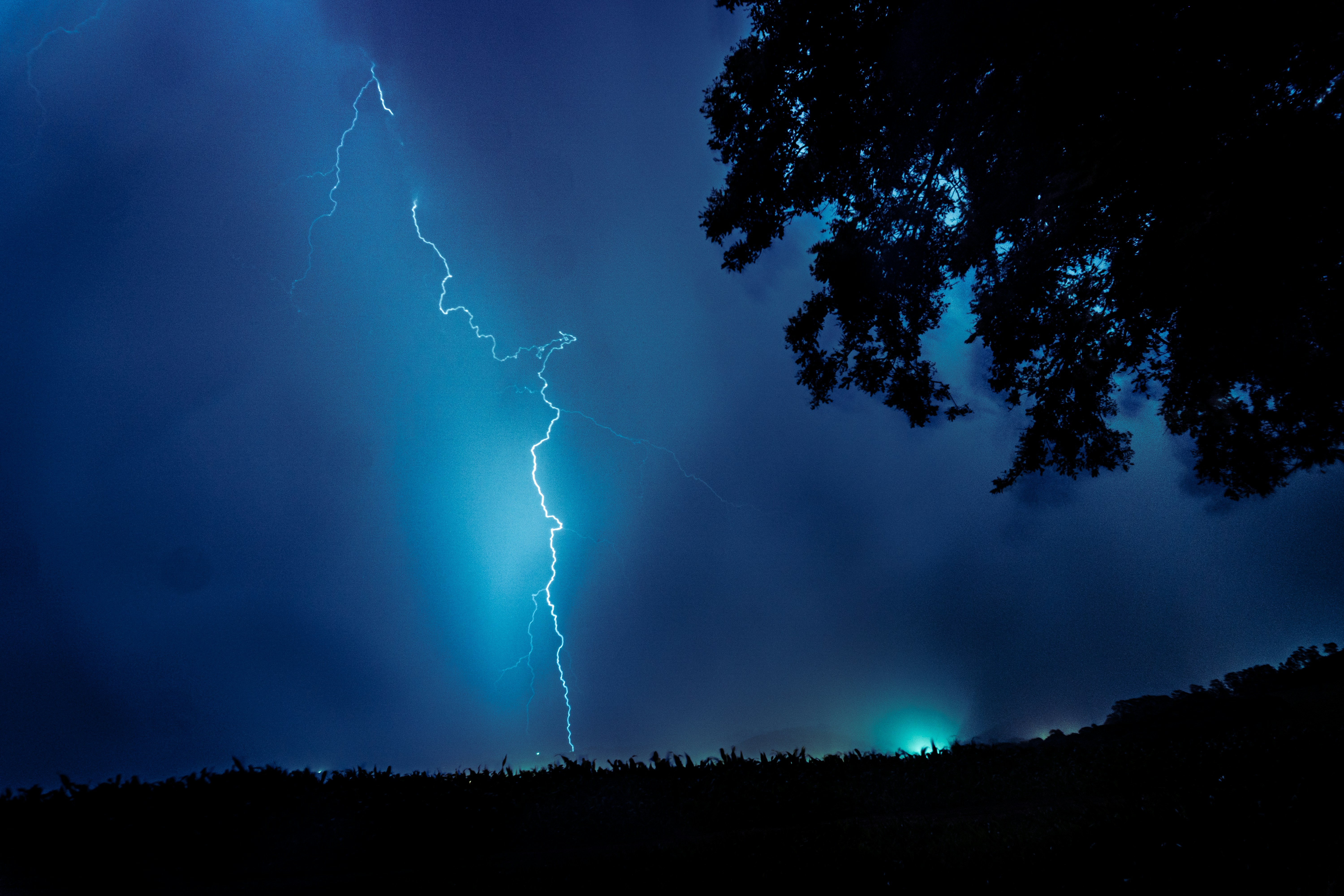 Lightning Cord Cut Across a Night Sky over a Silhouette Ridge