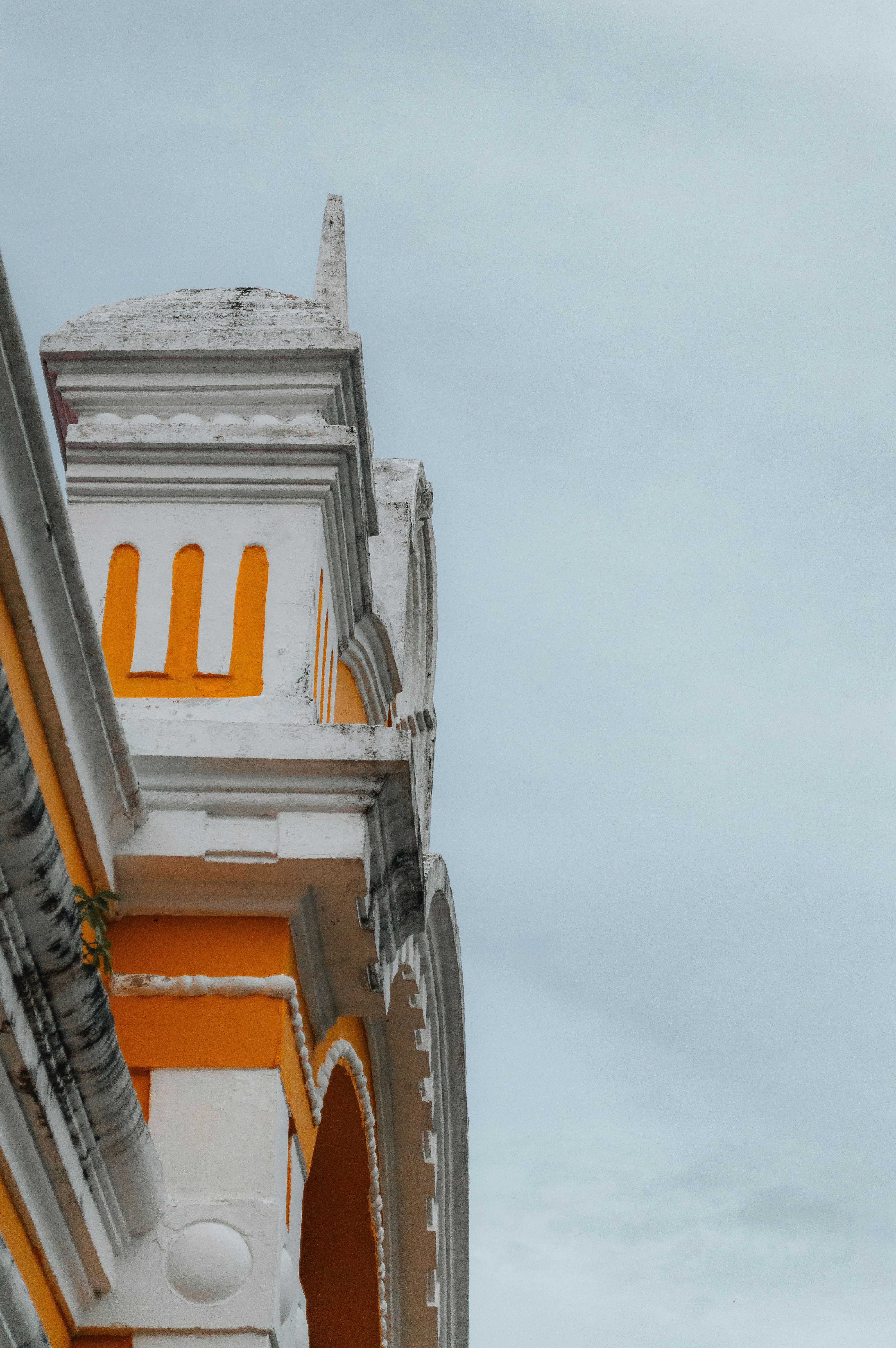 Architectural Orange: A tilted facade with sunlit arches