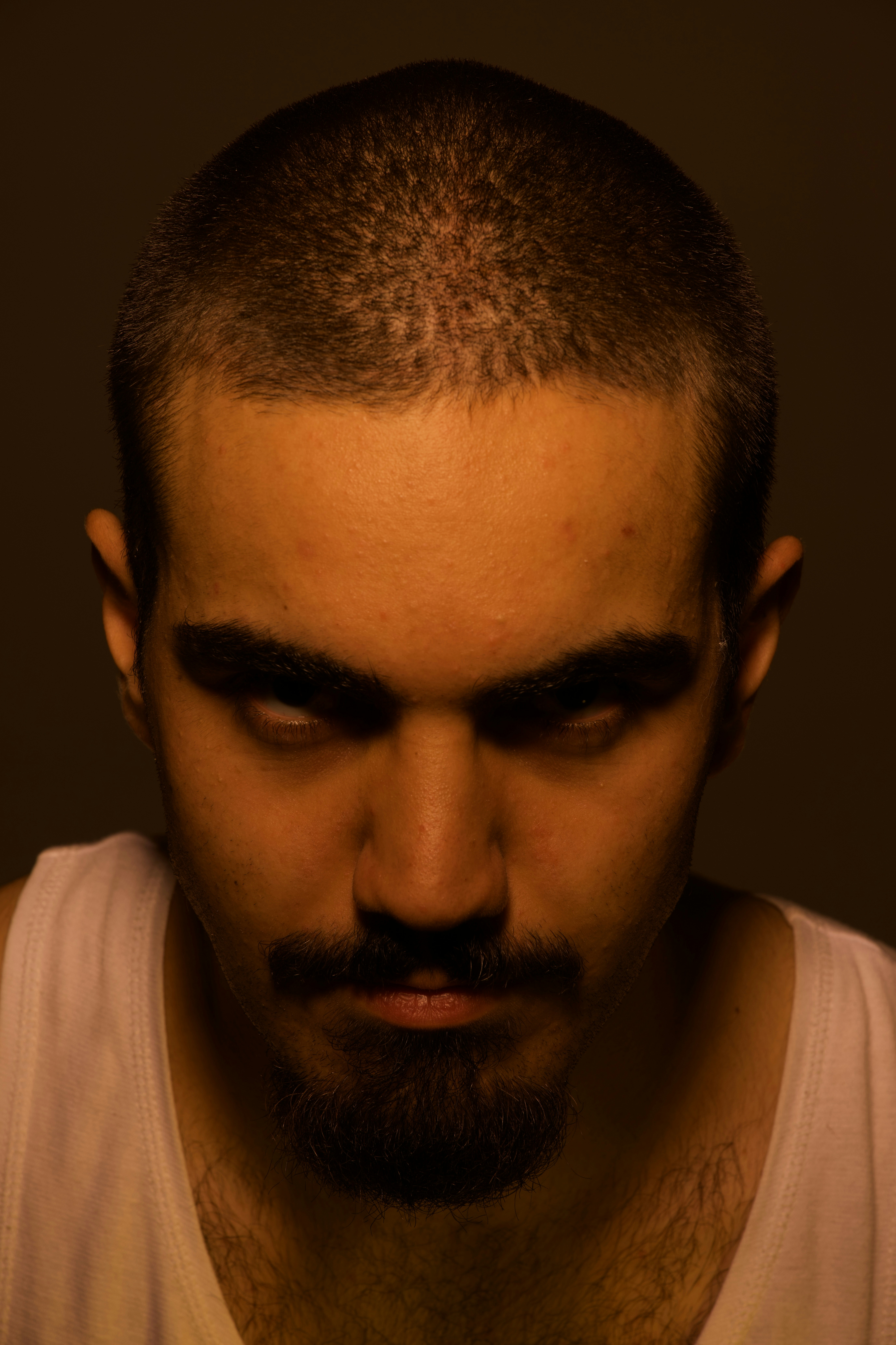 Low-key Gaze: A Steely Portrait in Ember Warmth