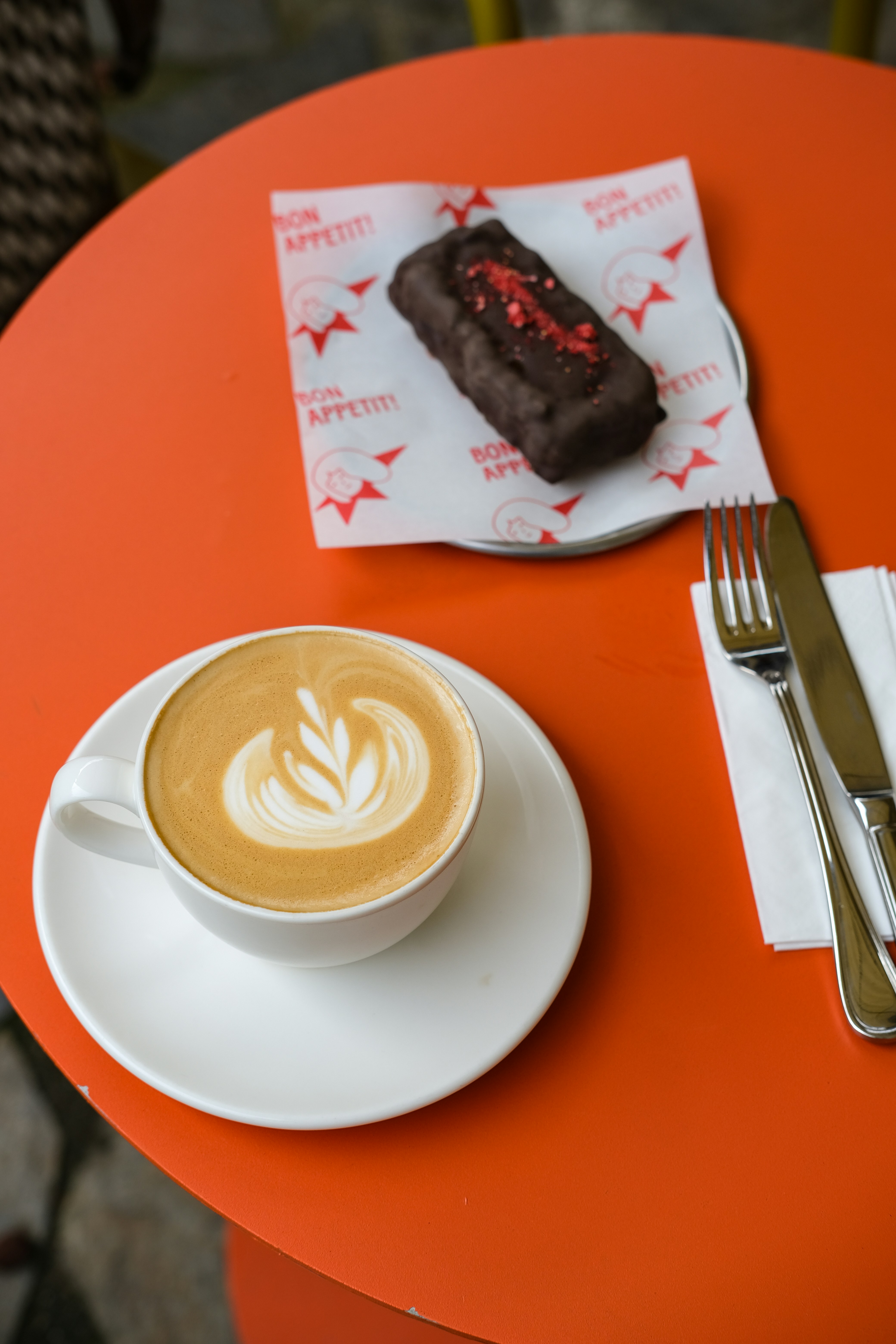 Cafe Comfort: A Cocoa Heart on a Bright Orange Table