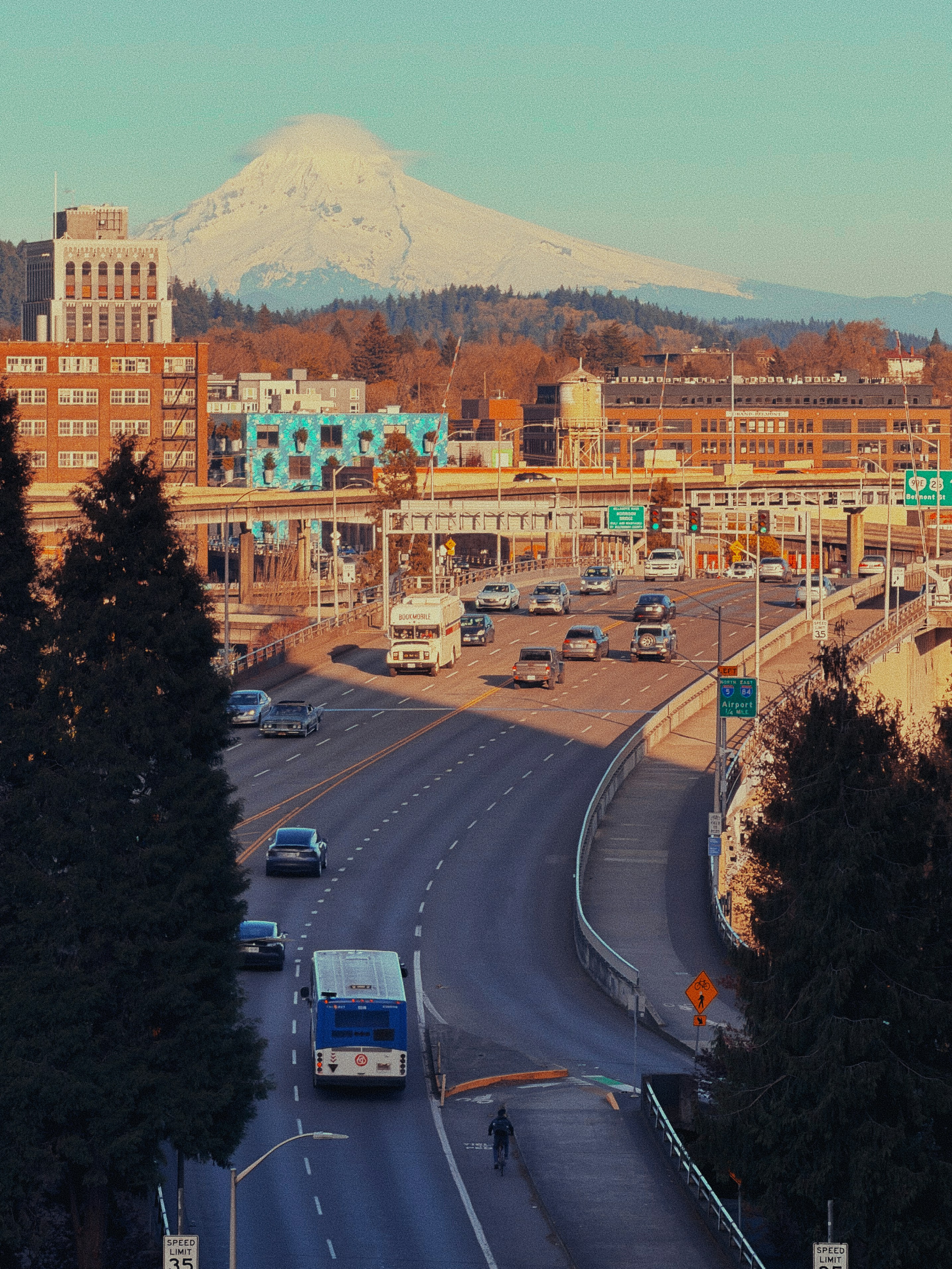Urban Highway Meets Snow-Capped Peak