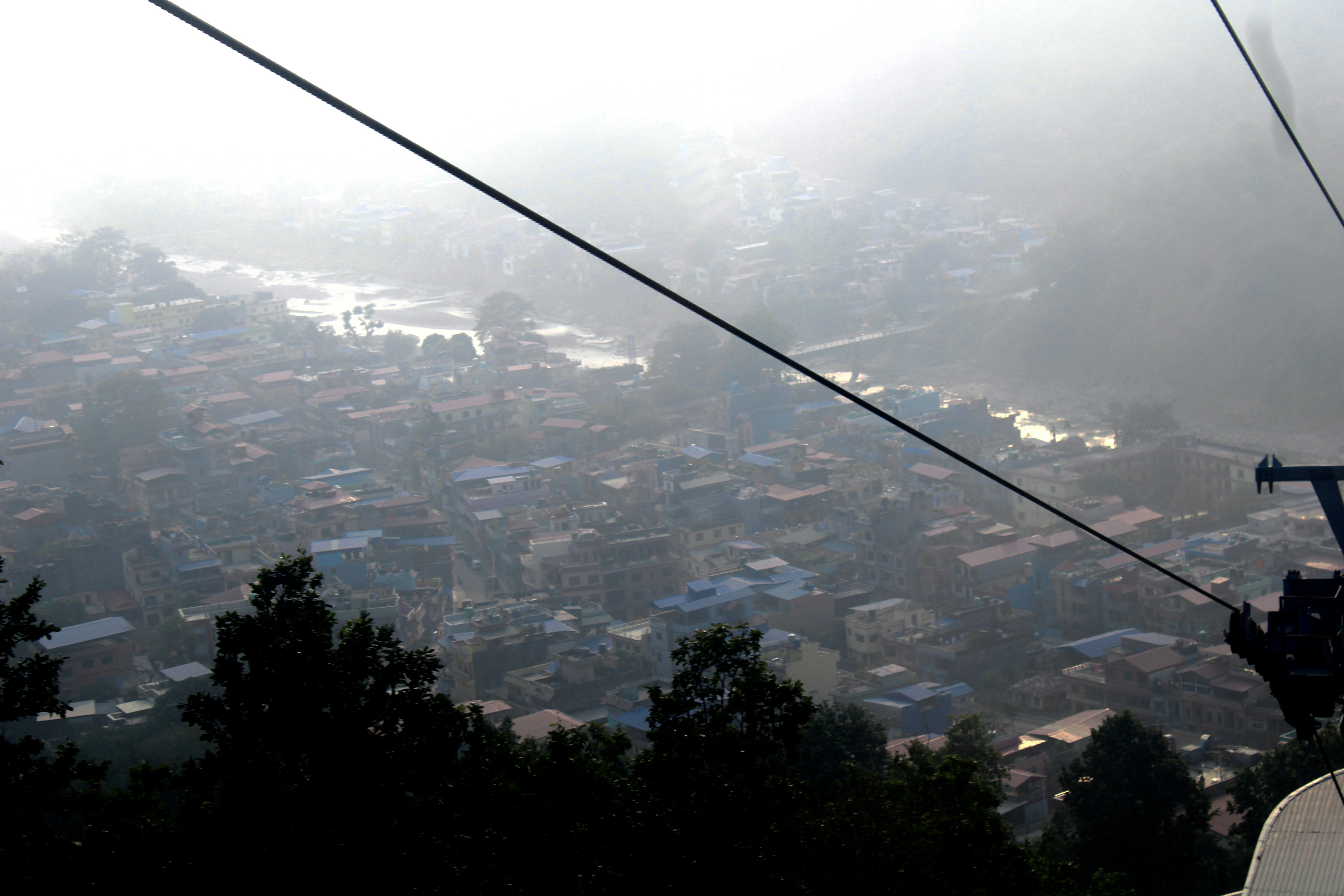 Cable Car Over a Misty Valley Village