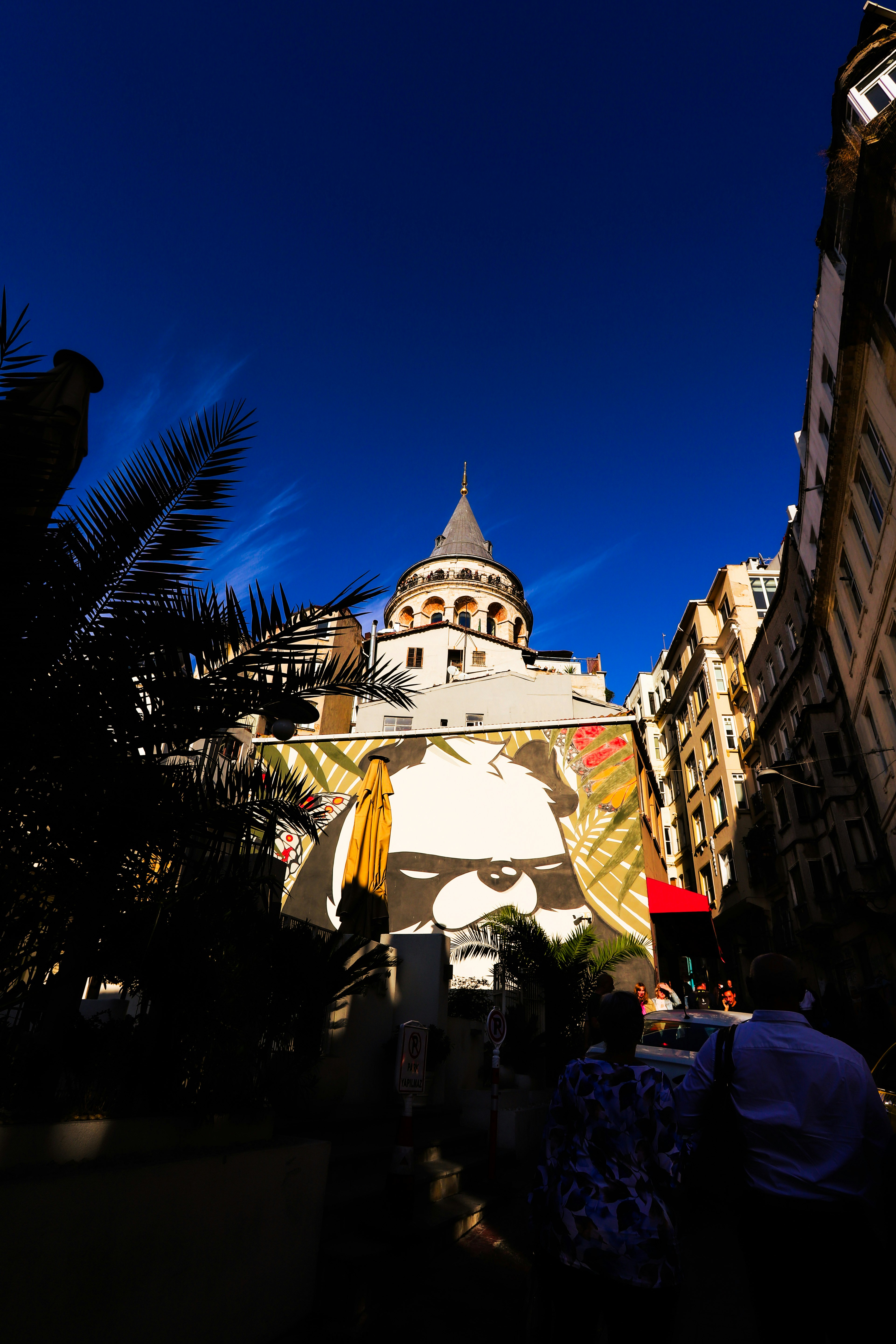 Urban mural beneath a cathedral dome: a sunlit courtyard scene