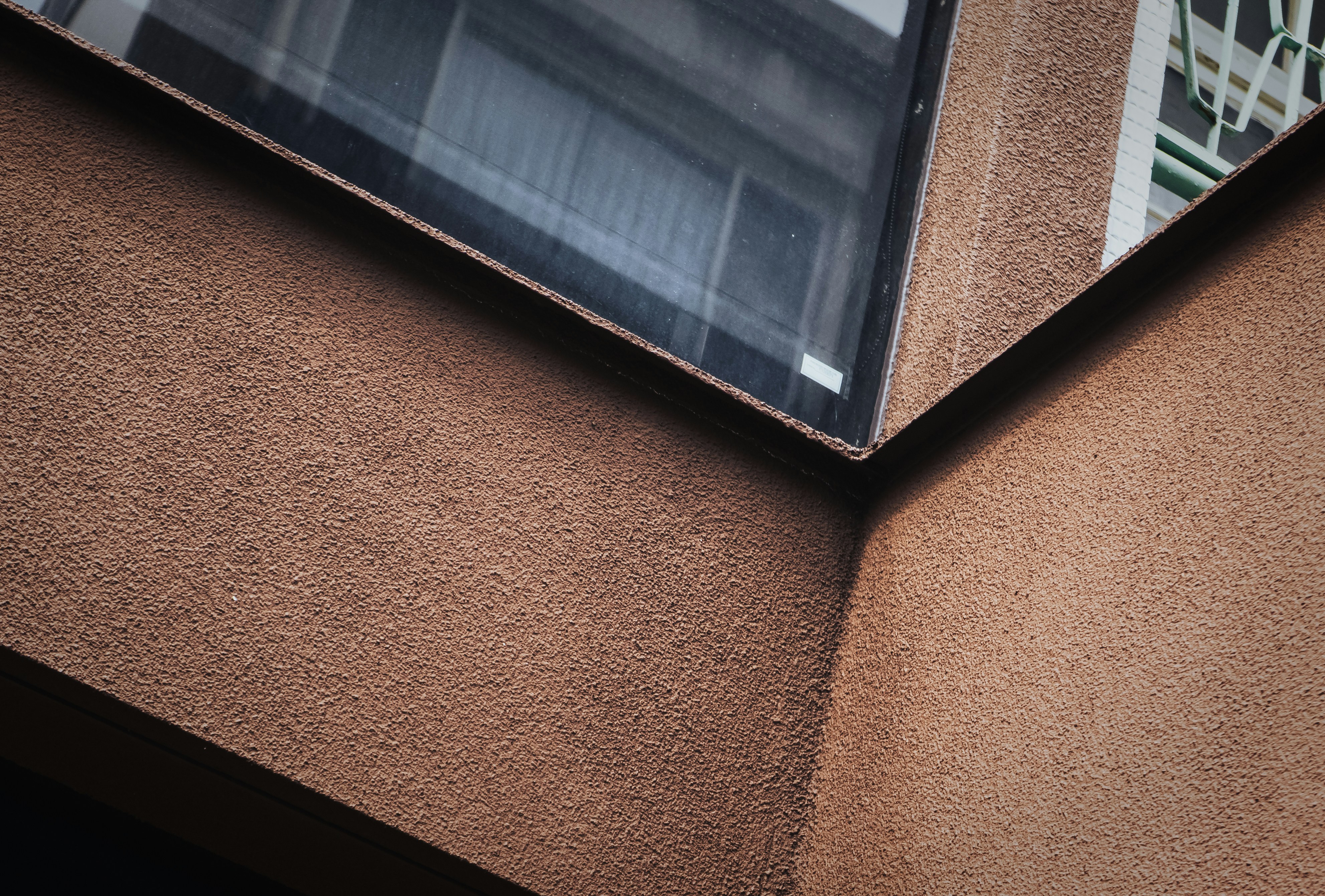 Angular Corner: Textured Terracotta Facade Meets Glazed Window Crease