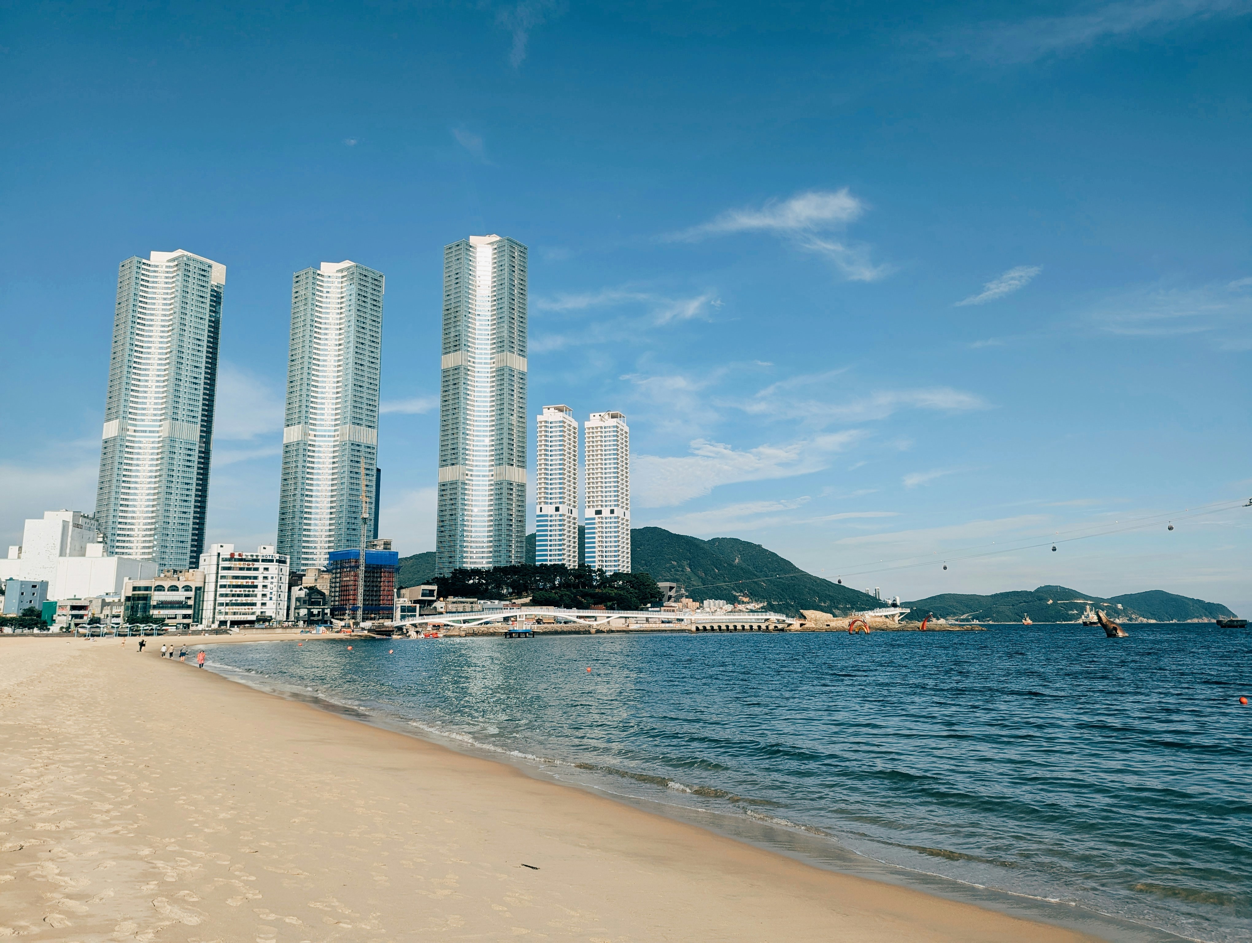 Urban Shoreline: Towers Rise Over Quiet Sand